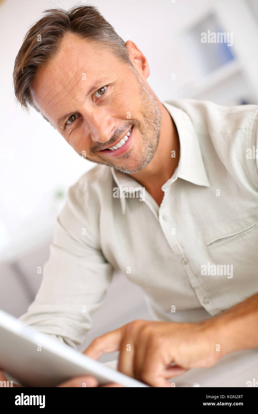 Handsome guy websurfing on internet with tablet Stock Photo - Alamy