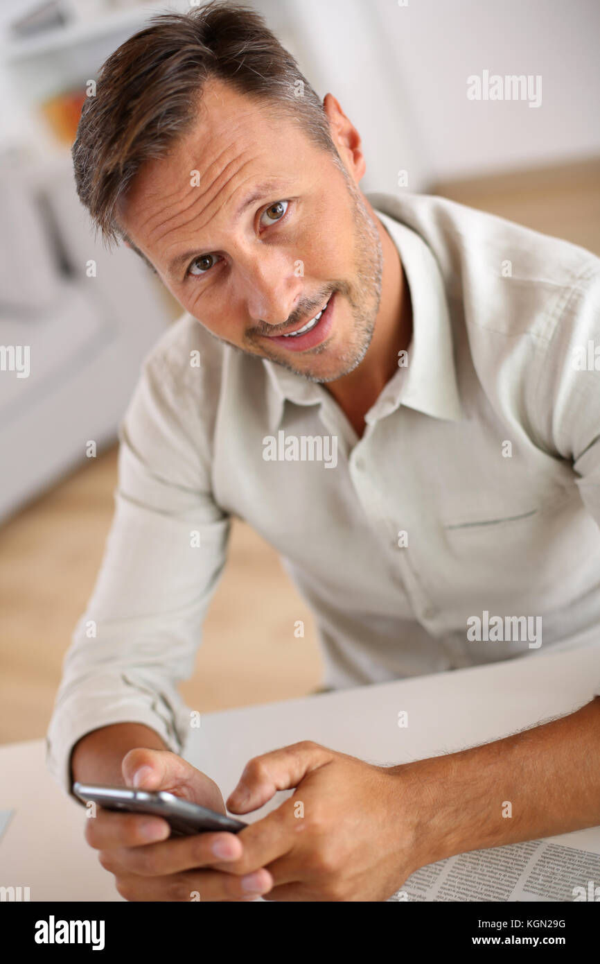 Smiling guy sending message hi-res stock photography and images - Alamy