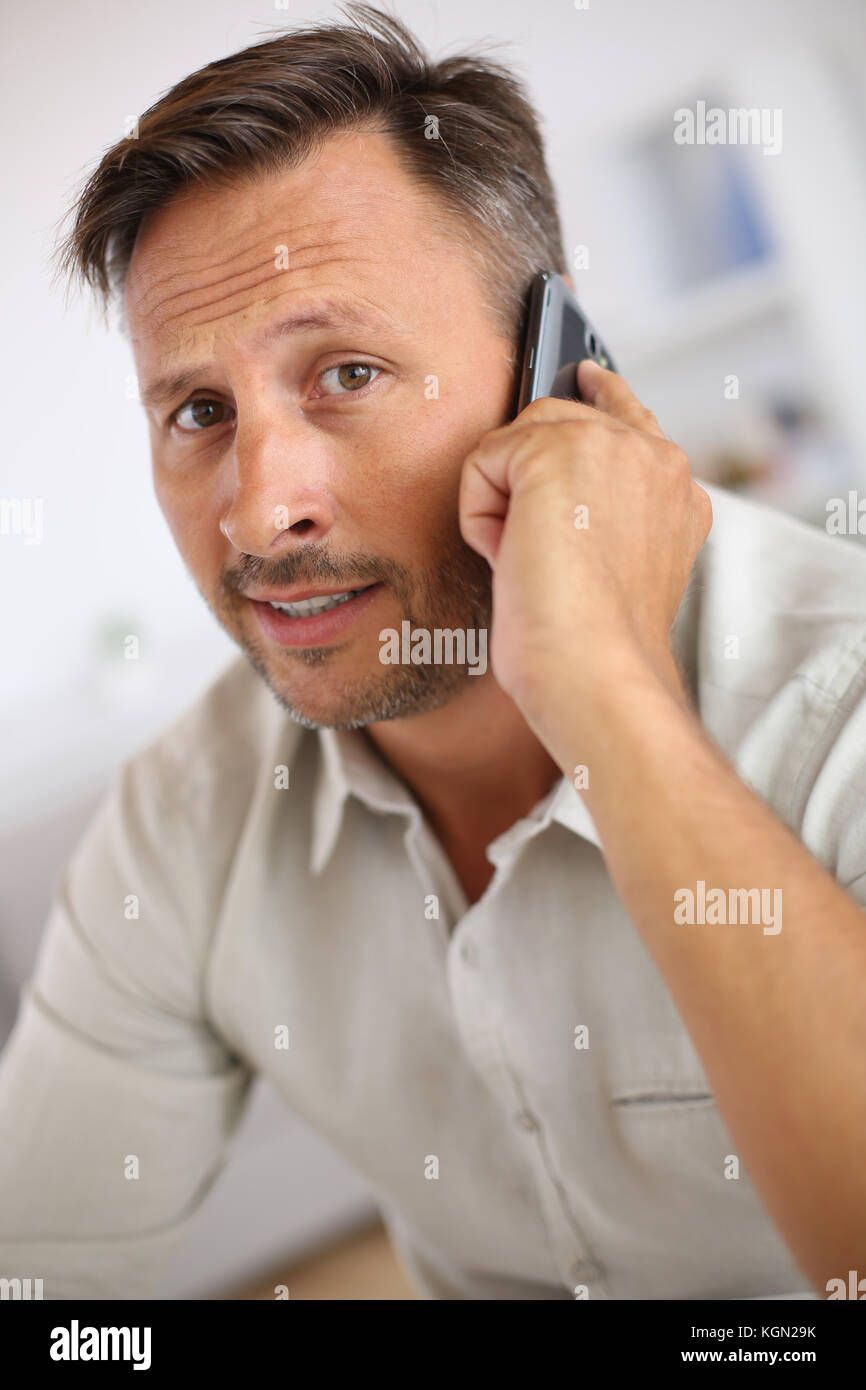 Smiling handsome guy talking on the phone Stock Photo - Alamy