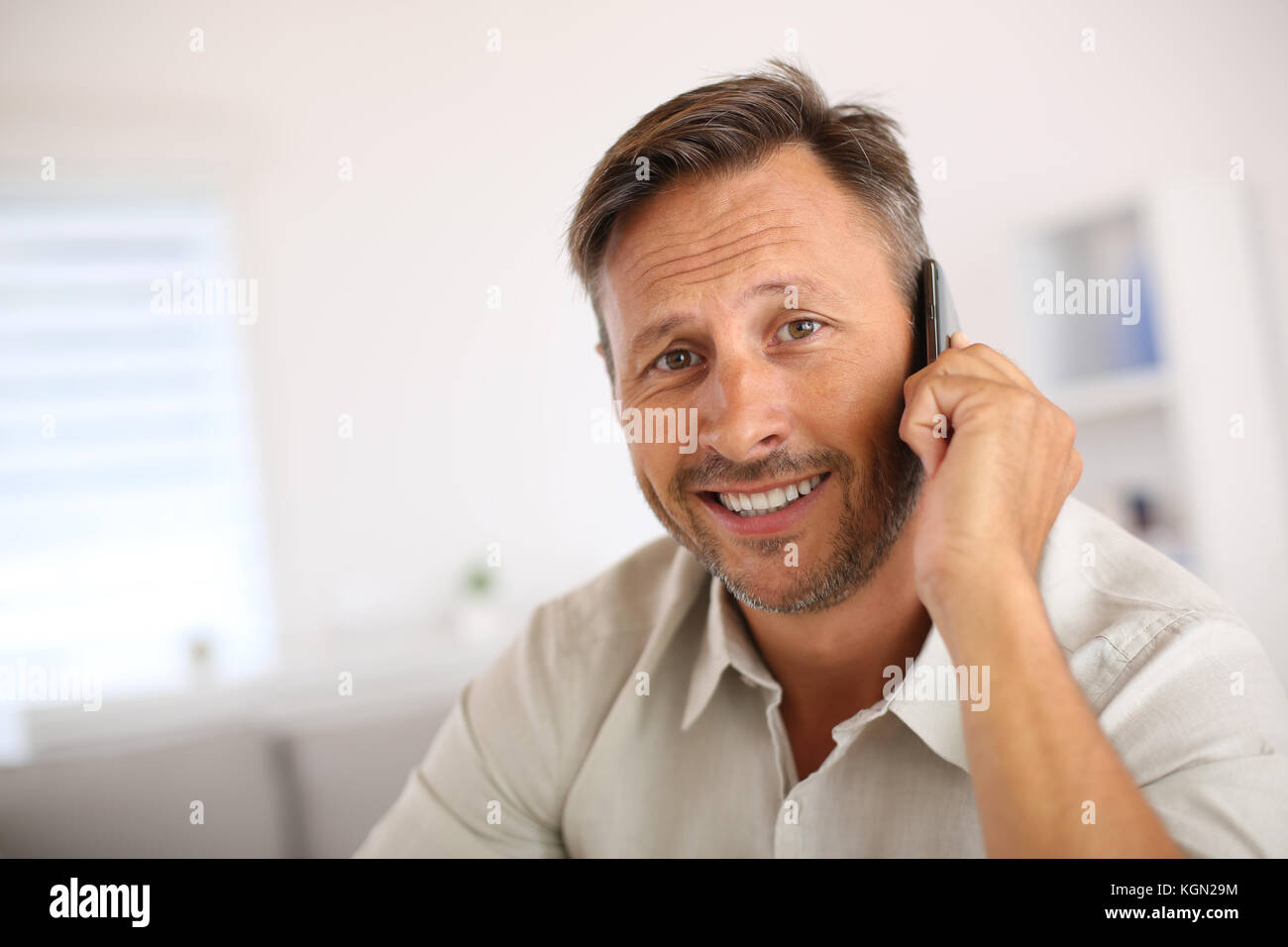 Smiling handsome guy talking on the phone Stock Photo - Alamy