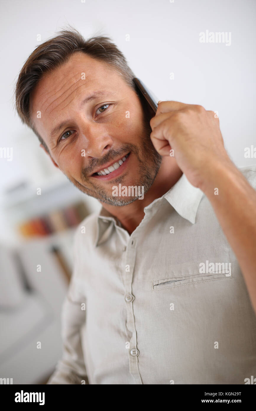Smiling handsome guy talking on the phone Stock Photo - Alamy