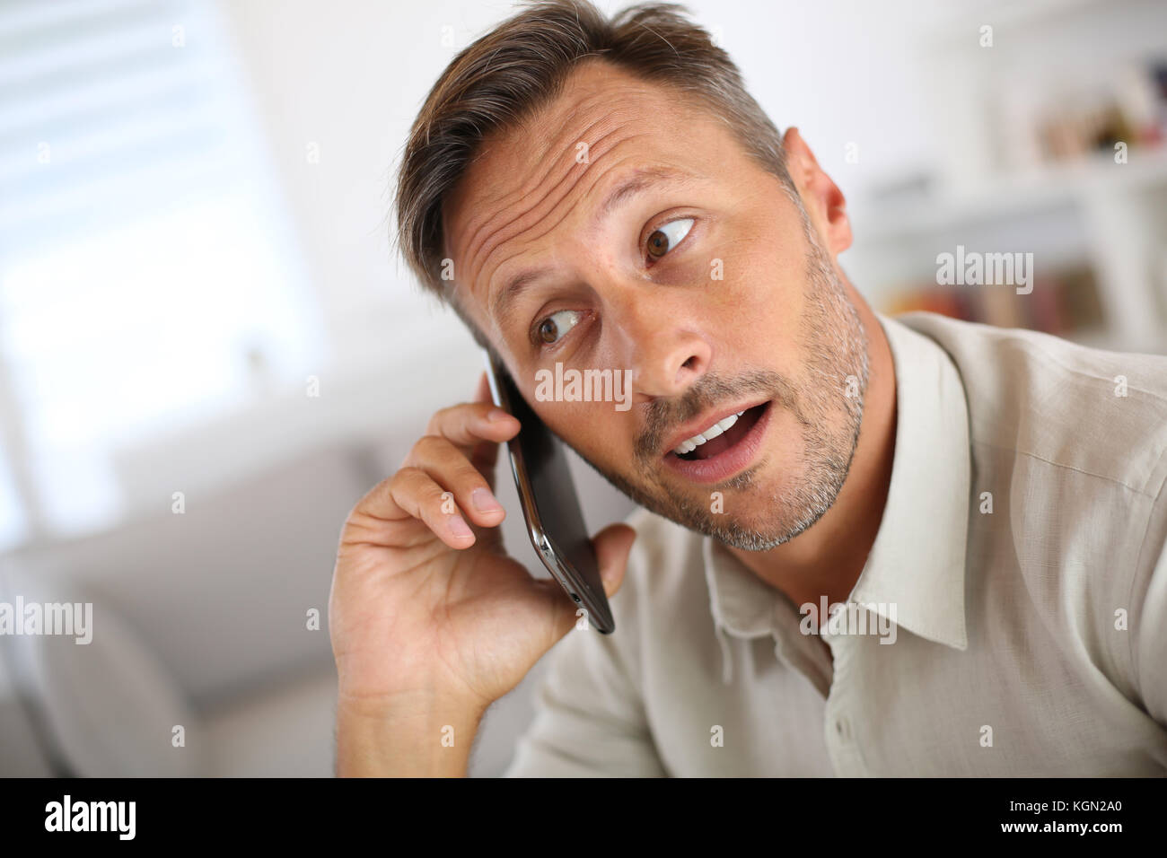 Smiling handsome guy talking on the phone Stock Photo - Alamy