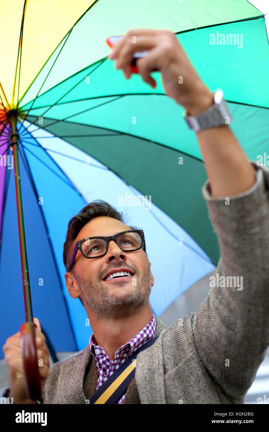 Man rainbow umbrella hi-res stock photography and images - Alamy
