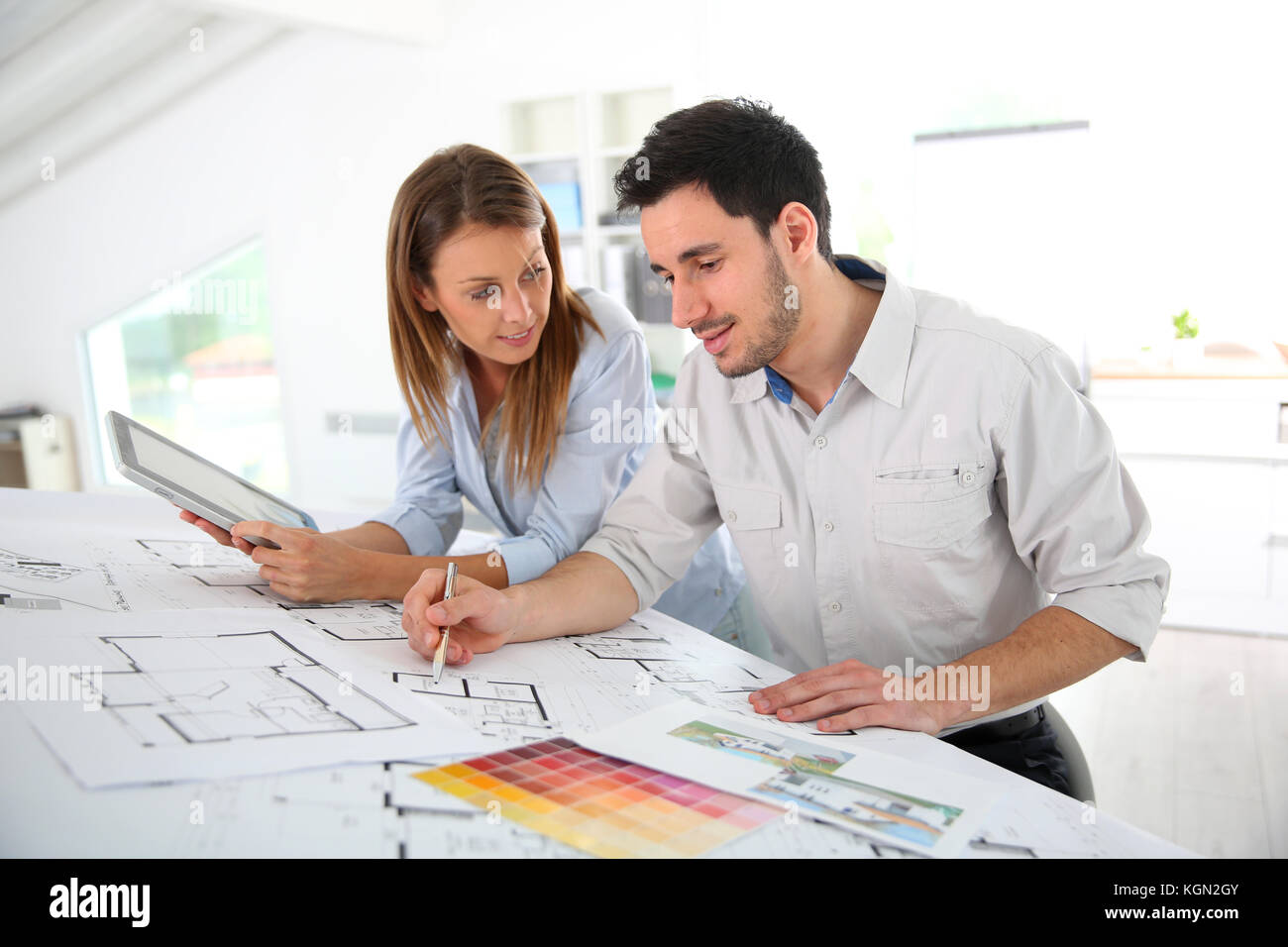 Team of architects working together on project Stock Photo - Alamy