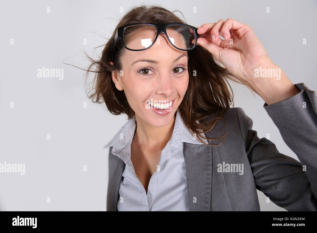 Funny businesswoman lifting eyeglasses up Stock Photo - Alamy