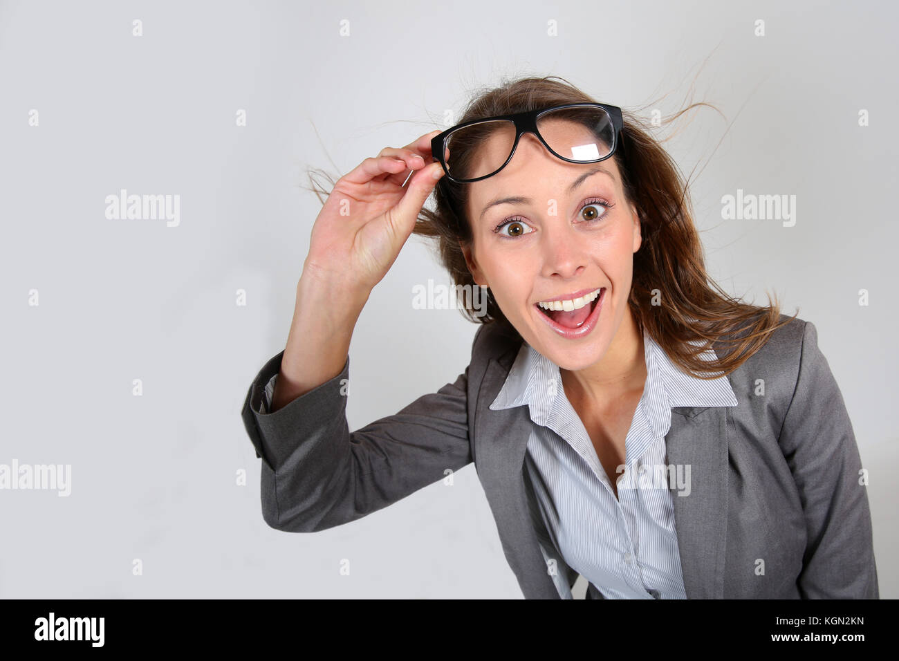 Funny businesswoman lifting eyeglasses up Stock Photo - Alamy