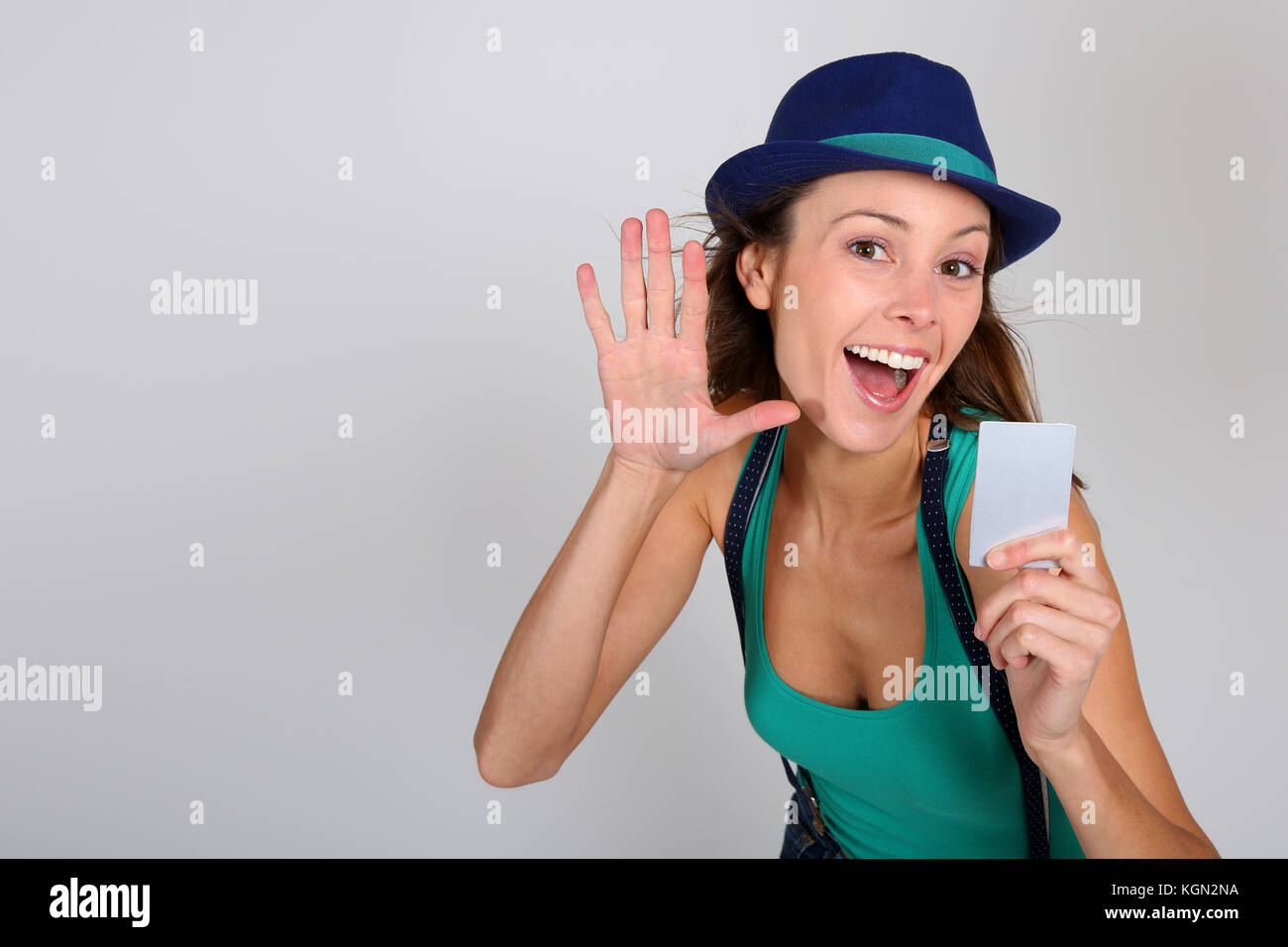 Beautiful stylish girl holding pass ticket Stock Photo - Alamy