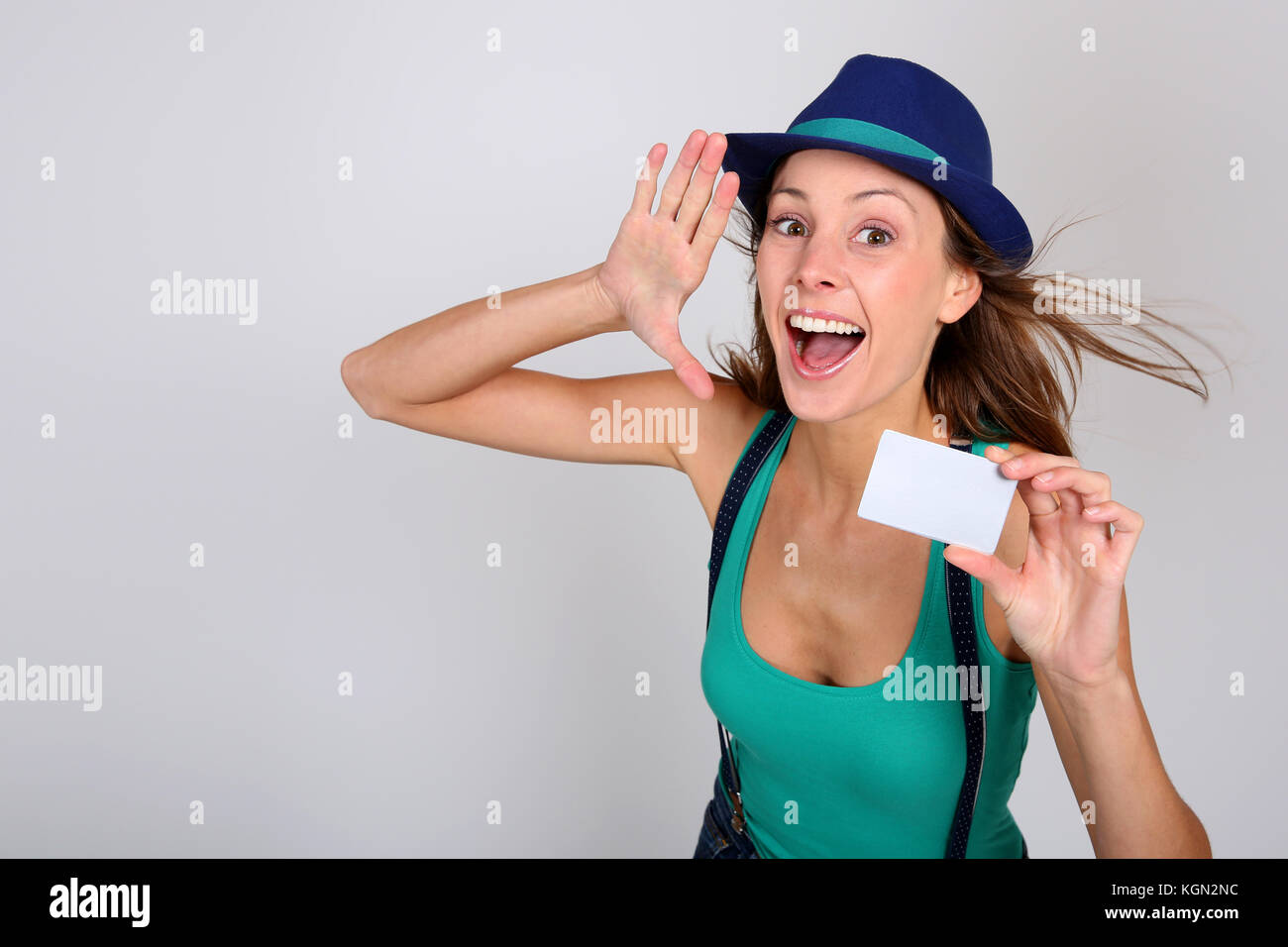 Beautiful stylish girl holding pass ticket Stock Photo - Alamy