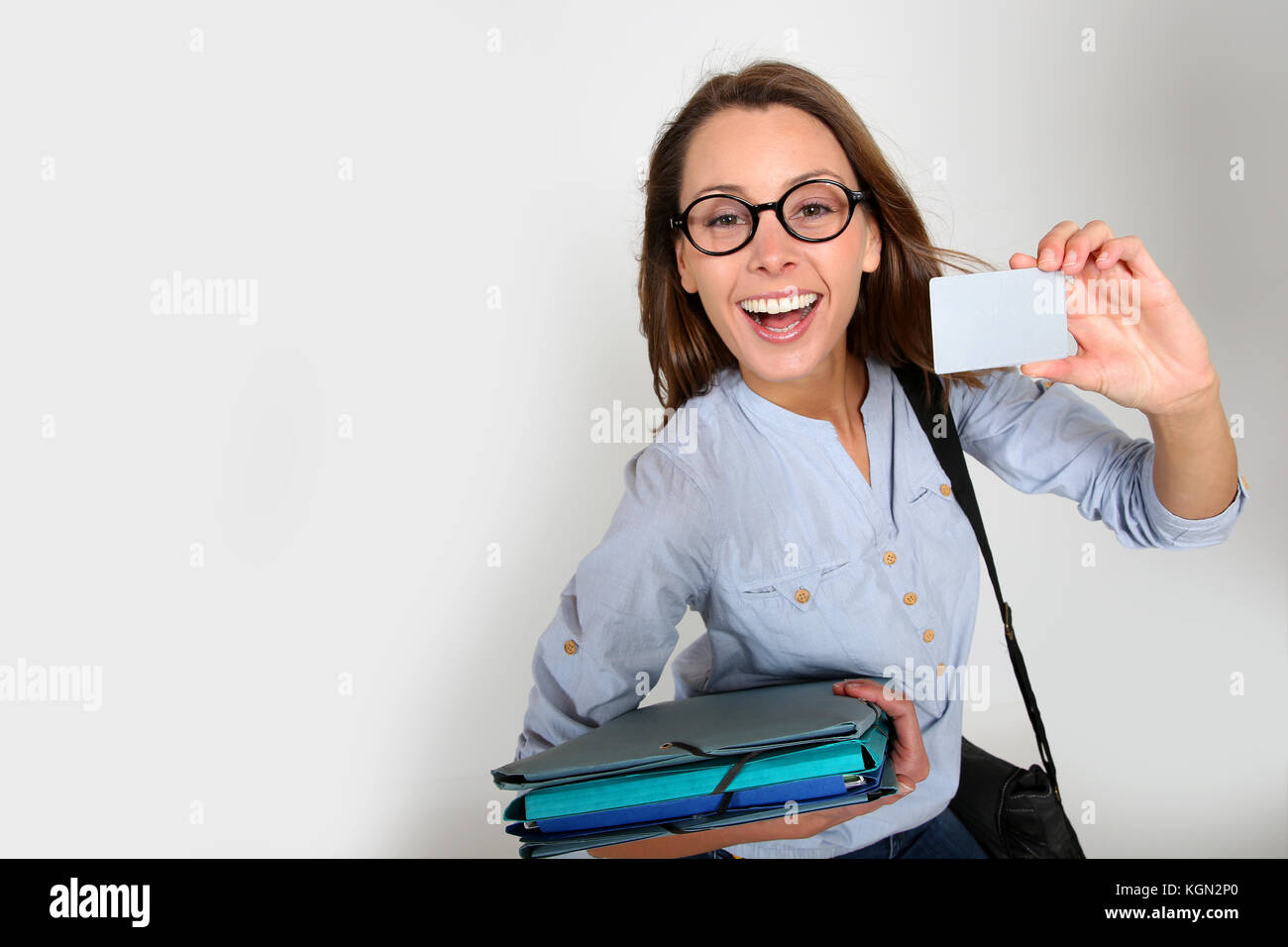 Smiling student girl showing college pass Stock Photo - Alamy