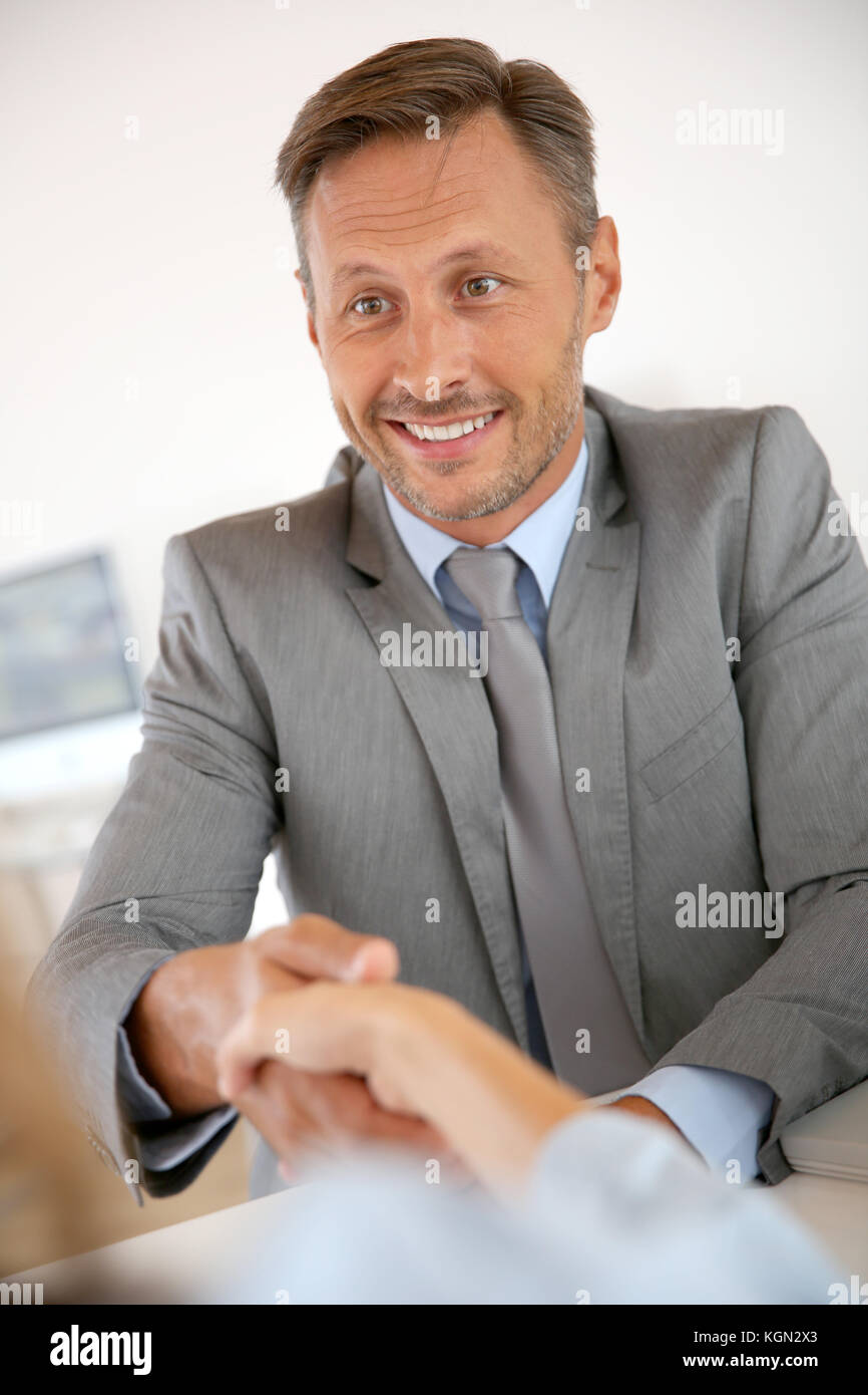 Man shaking hand to job applicant after interview Stock Photo - Alamy