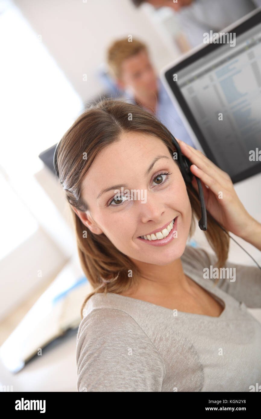 Beautiful smiling teleoperator with headset on Stock Photo - Alamy