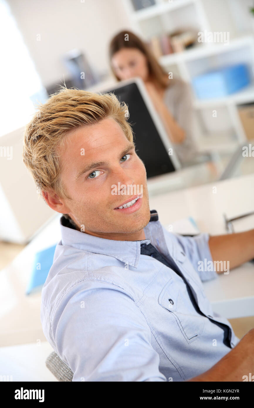 Young salesman working in office Stock Photo - Alamy
