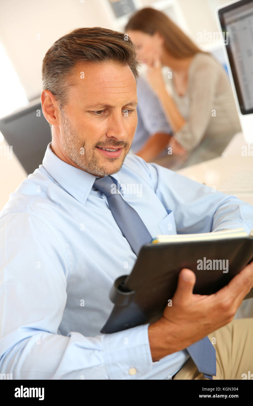 Portrait of handsome businessman holding agenda Stock Photo - Alamy Portrait of handsome businessman holding agenda Stock Photo - Alamy