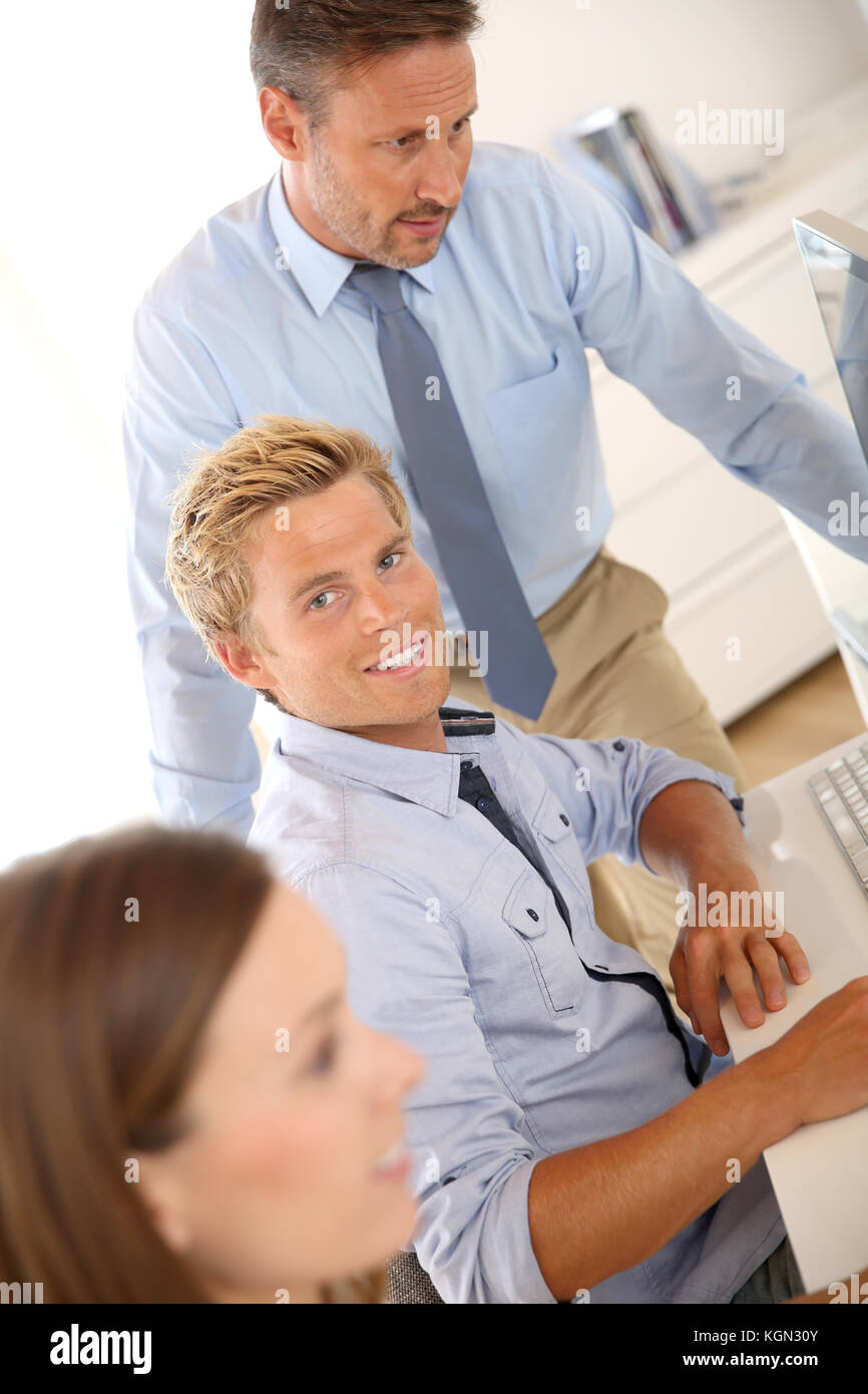 Young people attending business course with instructor Stock Photo - Alamy