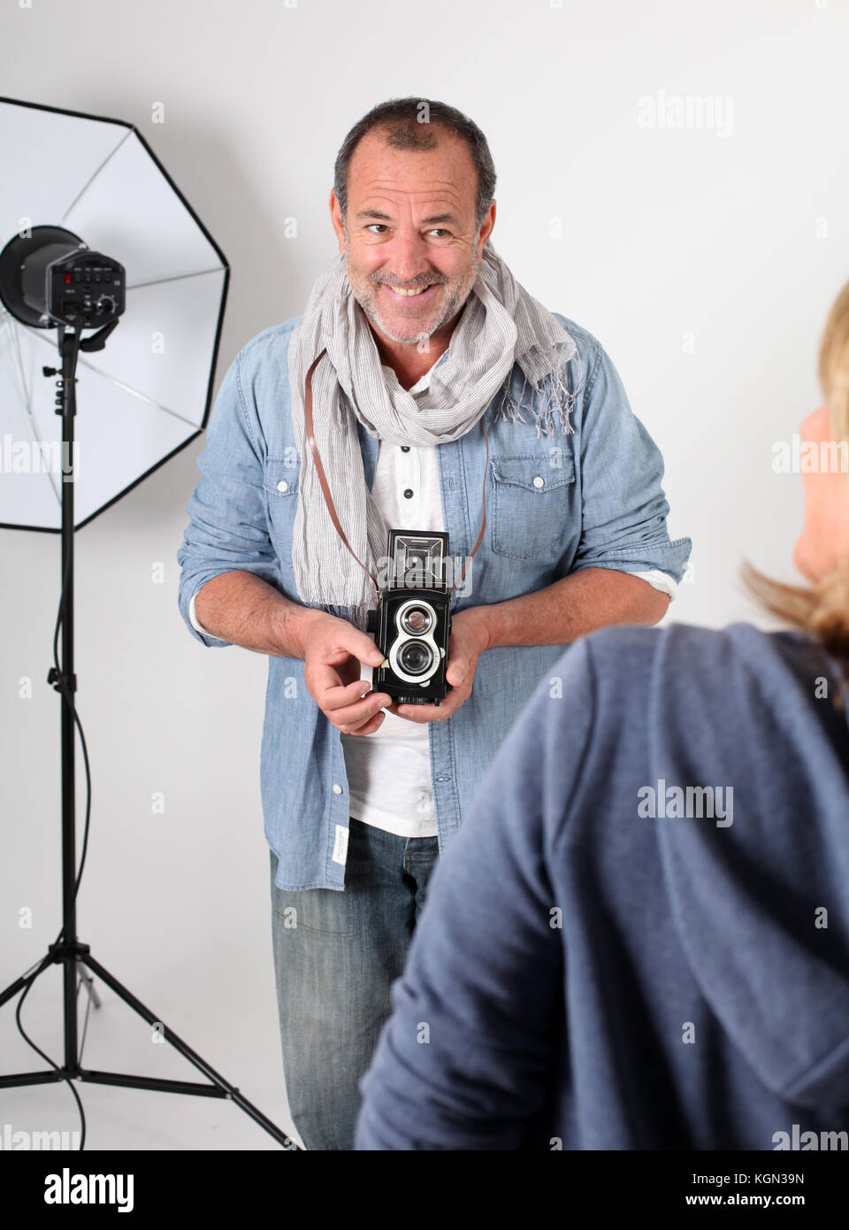 Photographer in photo session in studio Stock Photo - Alamy