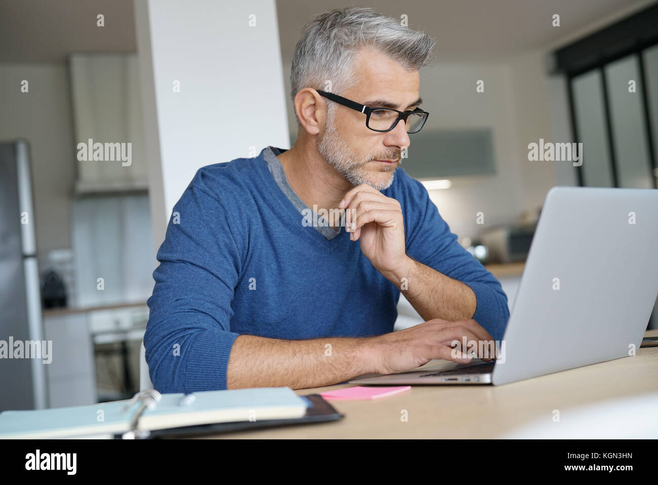 Middle-aged man working from home-office on laptop Stock Photo - Alamy