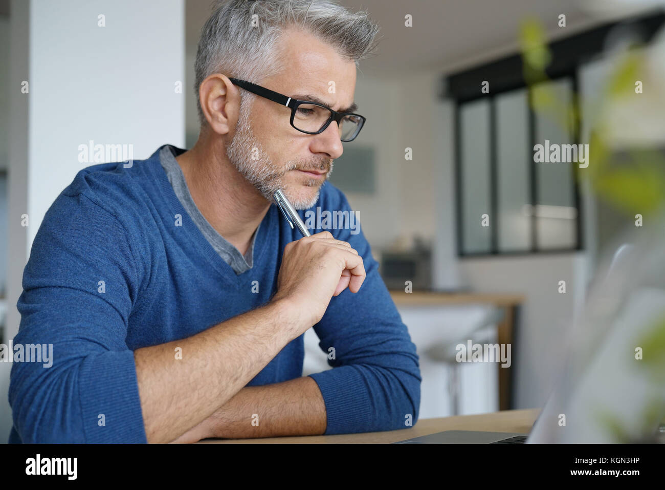 Middle-aged man working from home-office on laptop Stock Photo - Alamy