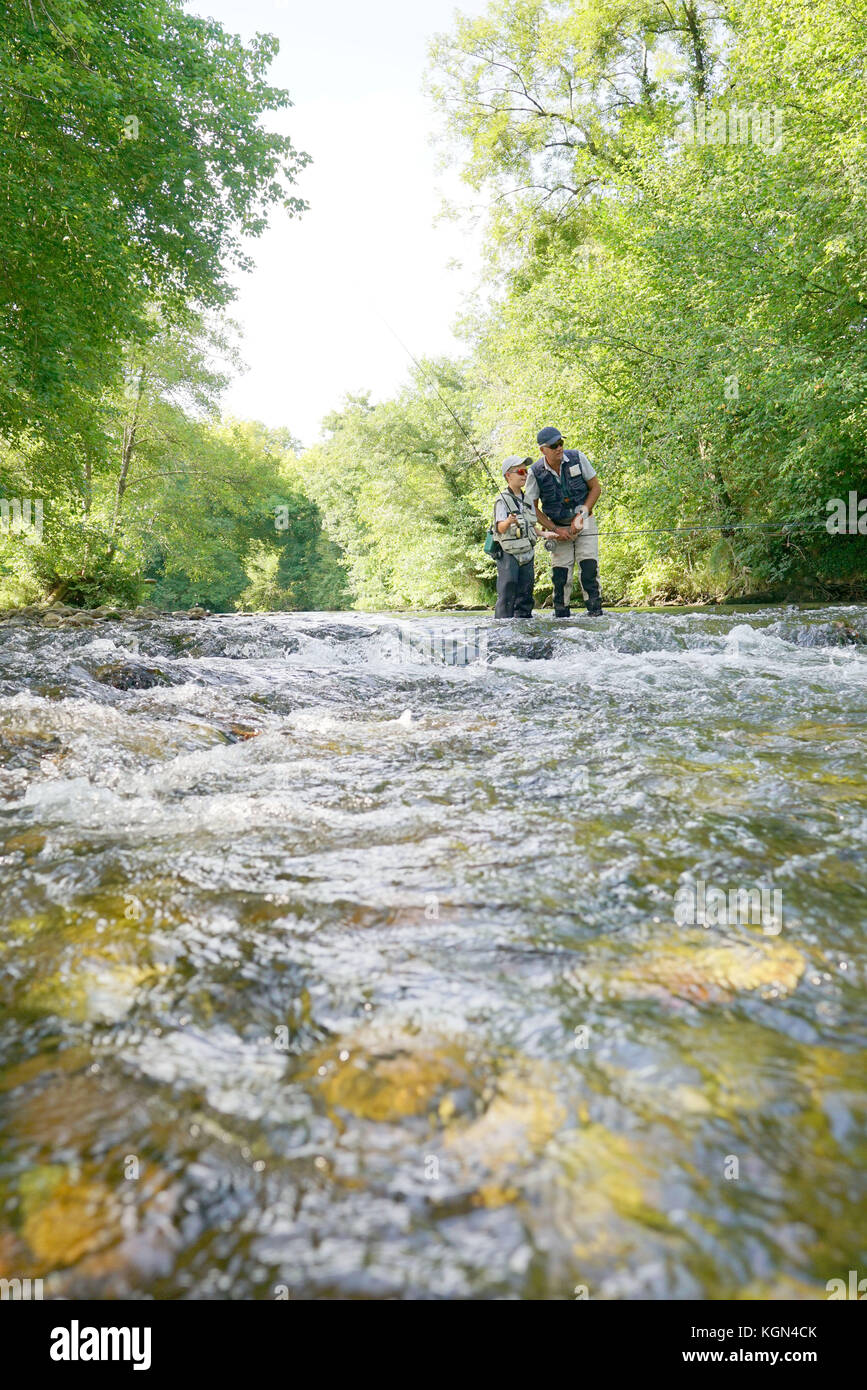 Father and son fly-fishing in river Stock Photo - Alamy