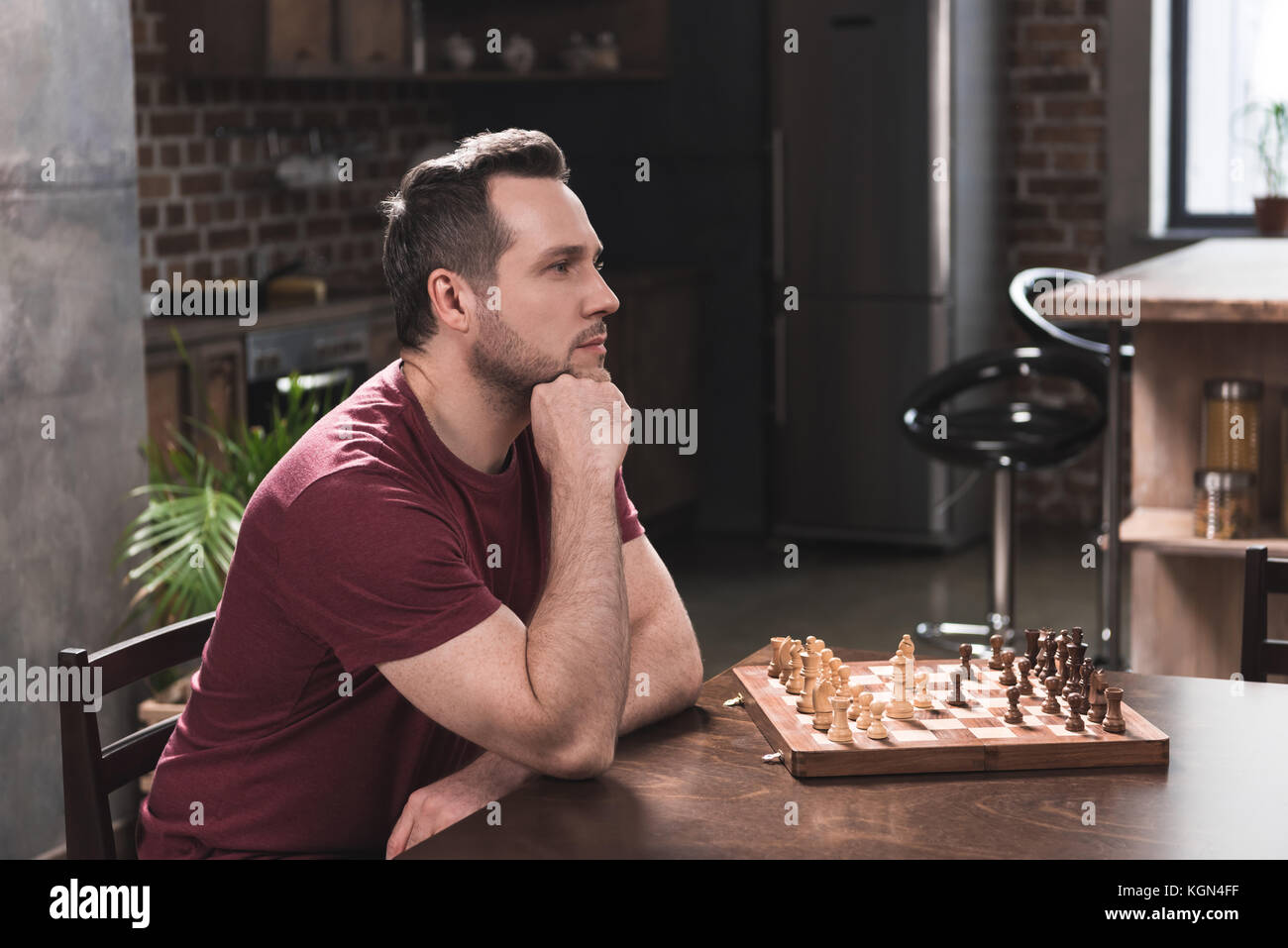 man thinking about move in chess Stock Photo - Alamy