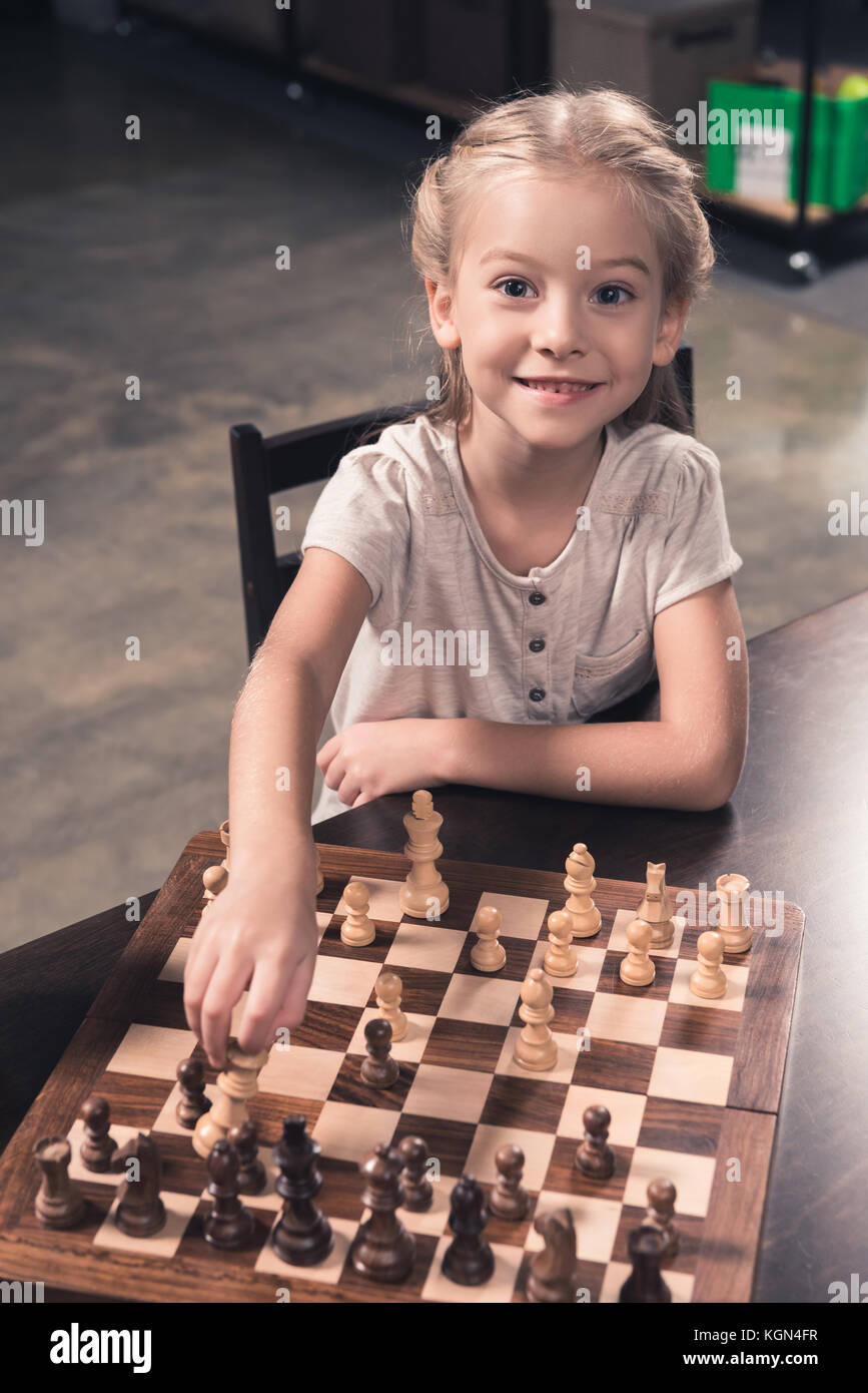 Preschooler child making move in chess Stock Photo - Alamy