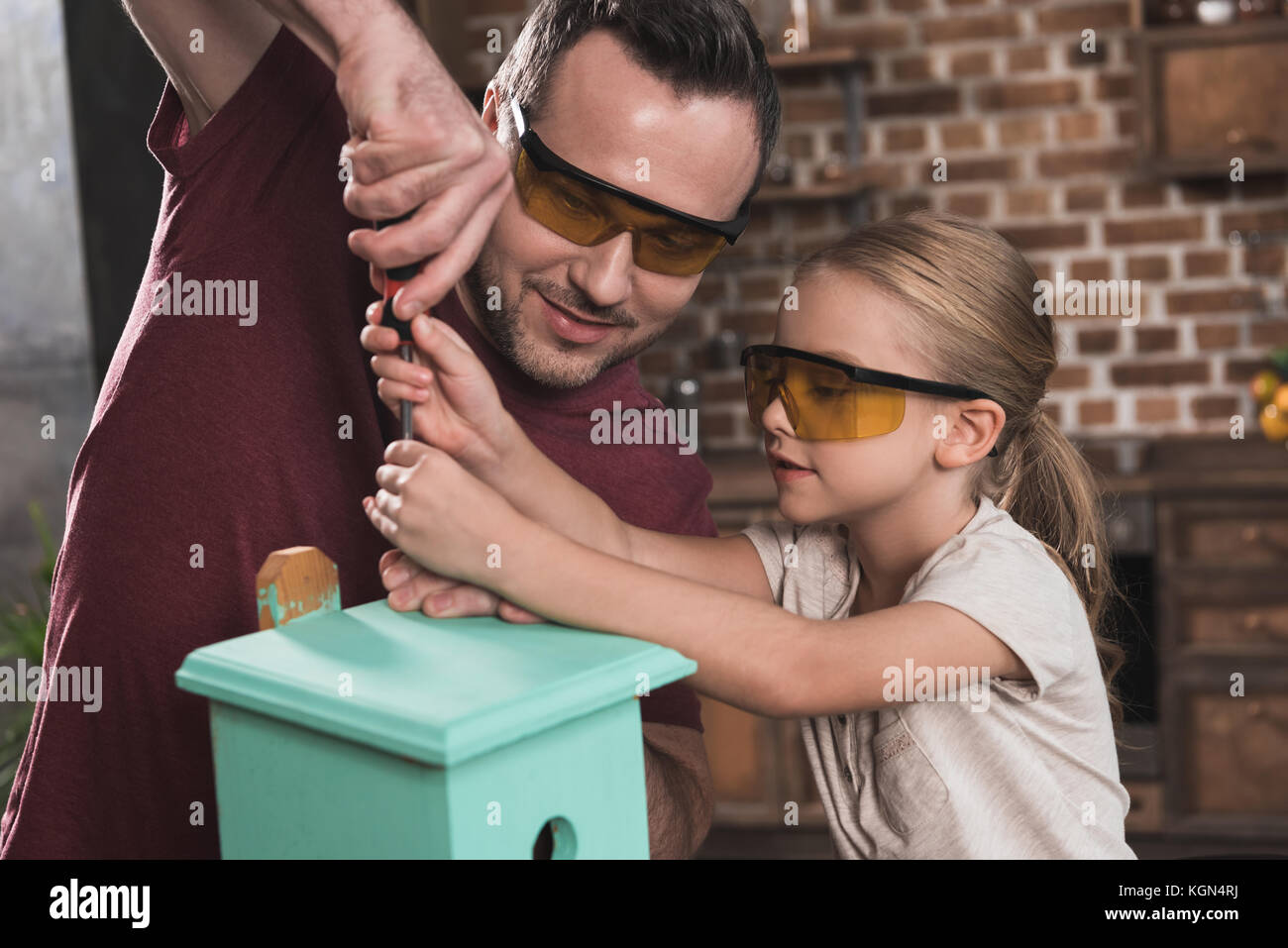 Daughter helping father hi-res stock photography and images - Alamy