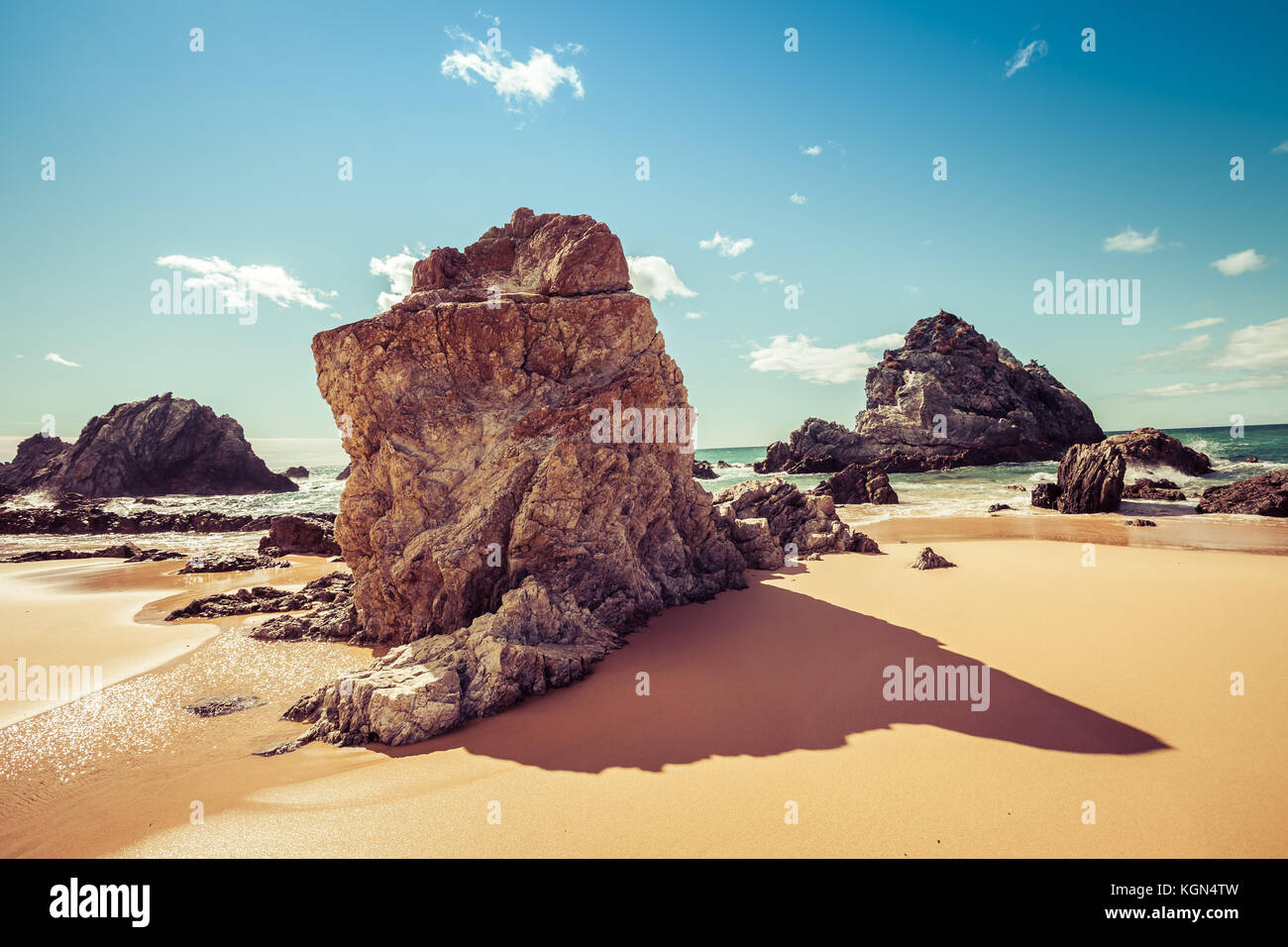Beautiful rock formation on ocean beach on bright sunny day Stock Photo ...