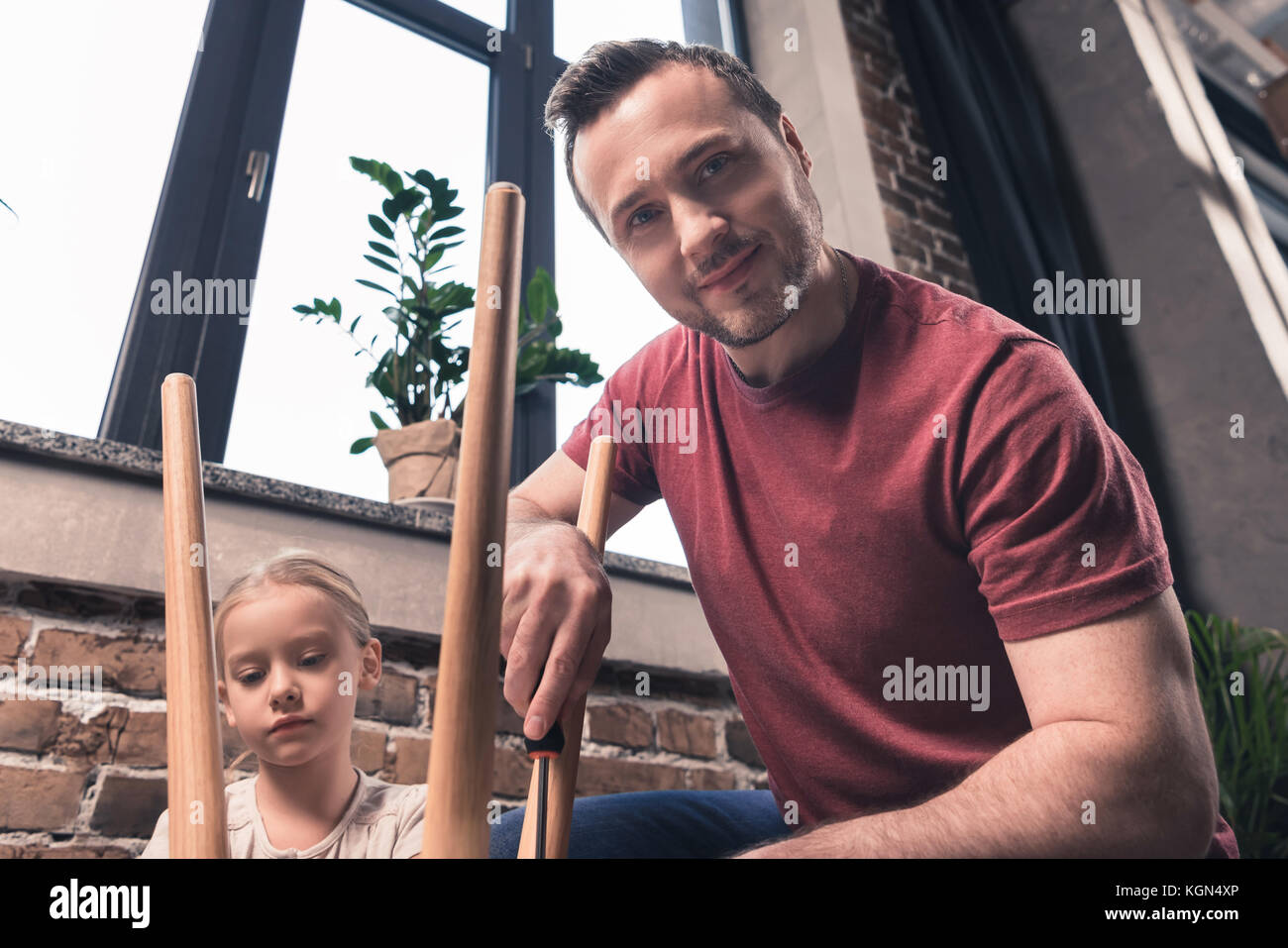 Father and daughter repairing table Stock Photo - Alamy