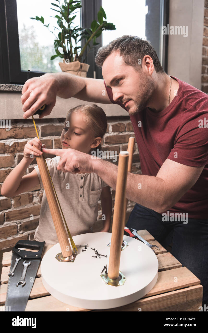 Father and daughter repairing table Stock Photo - Alamy