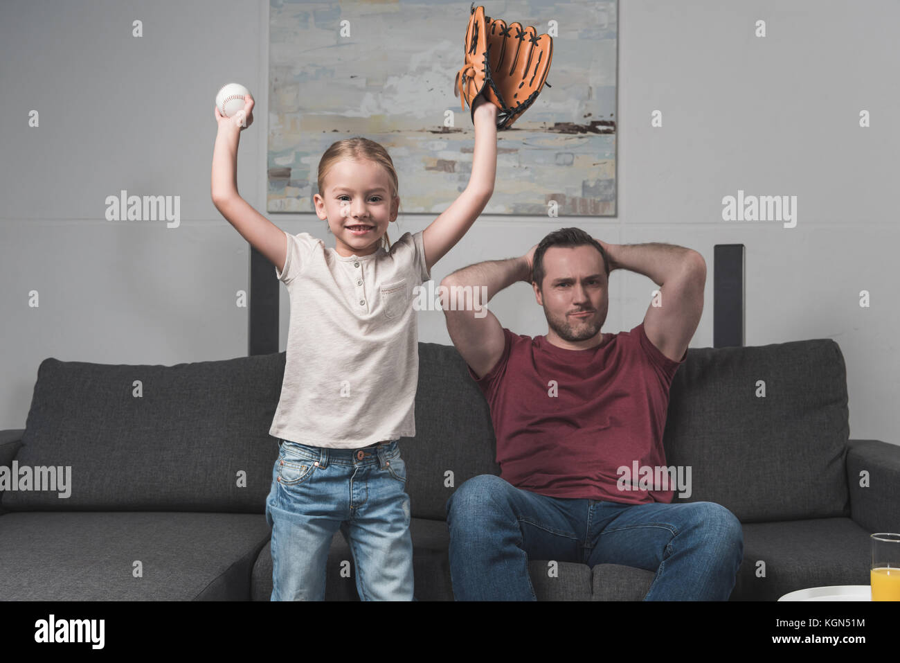 Daughter happy for favorite baseball team Stock Photo - Alamy