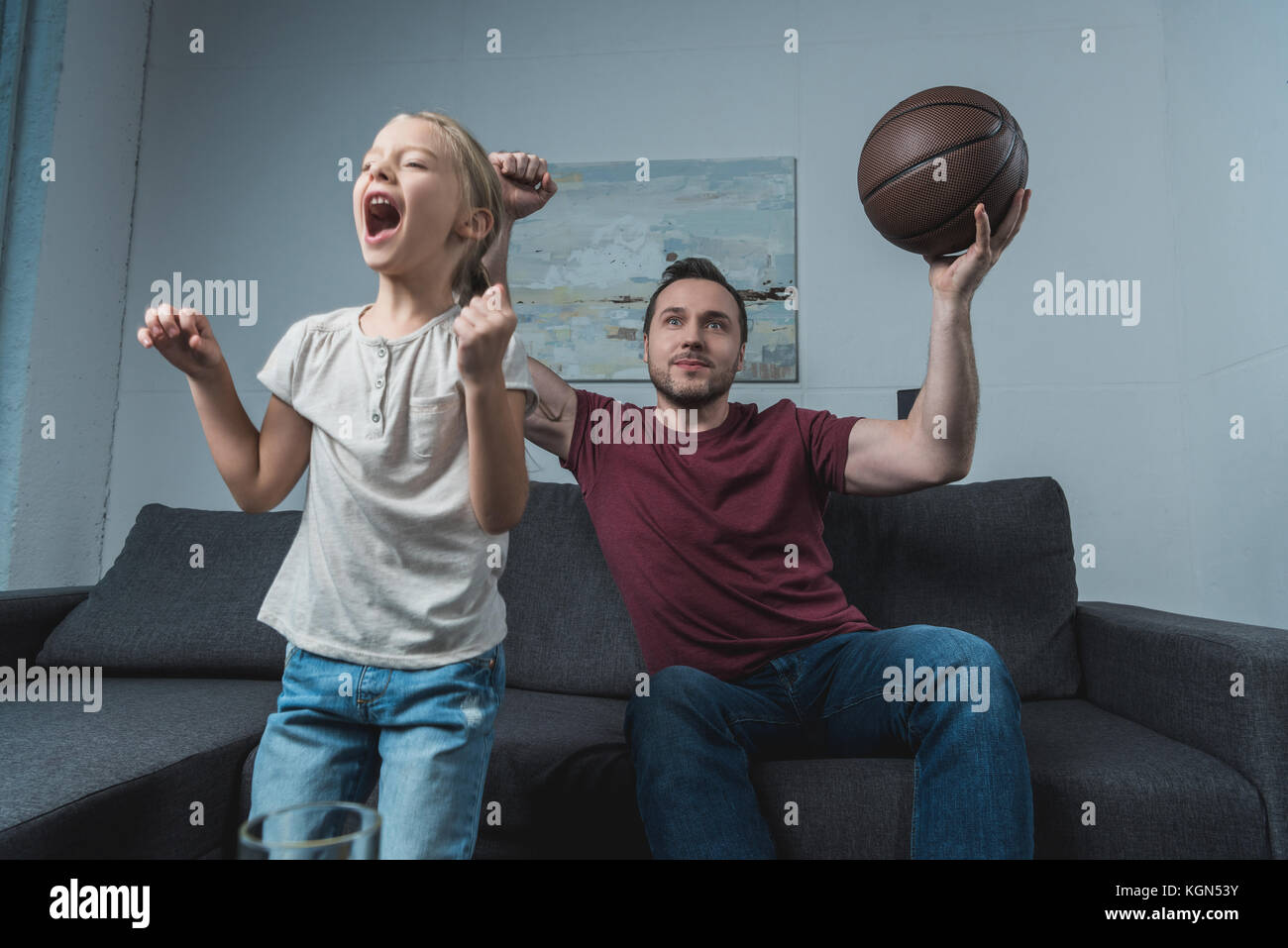 Father and daughter supporting basketball team Stock Photo - Alamy