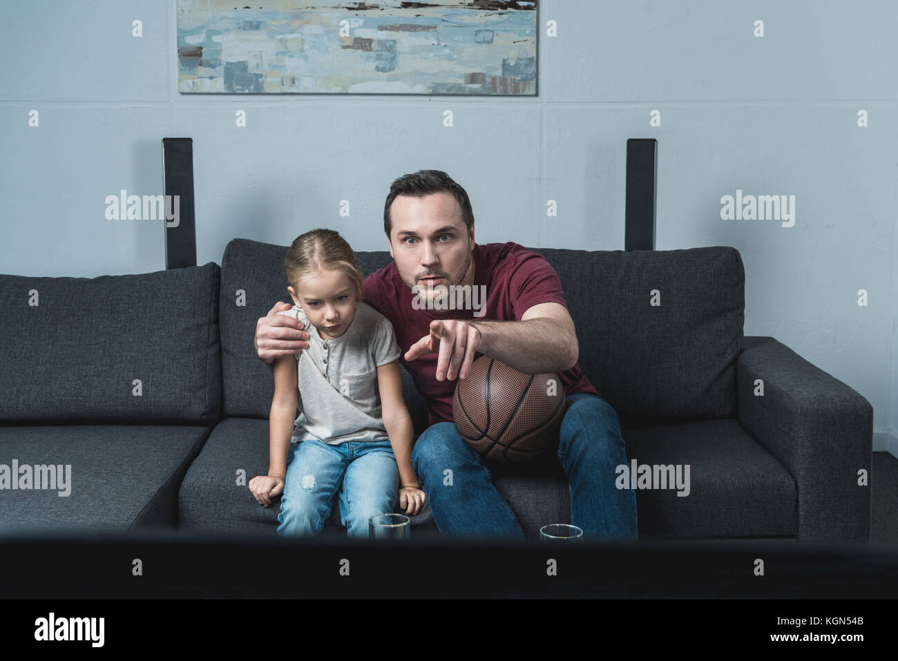 Father and daughter watching basketball game Stock Photo - Alamy
