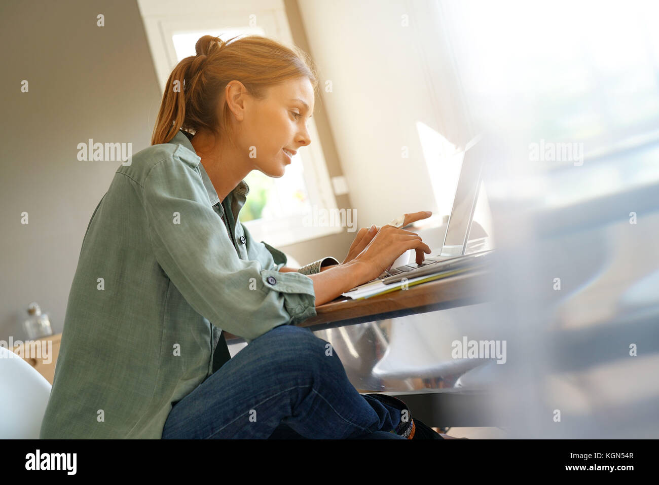 Trendy girl working from home on laptop Stock Photo - Alamy