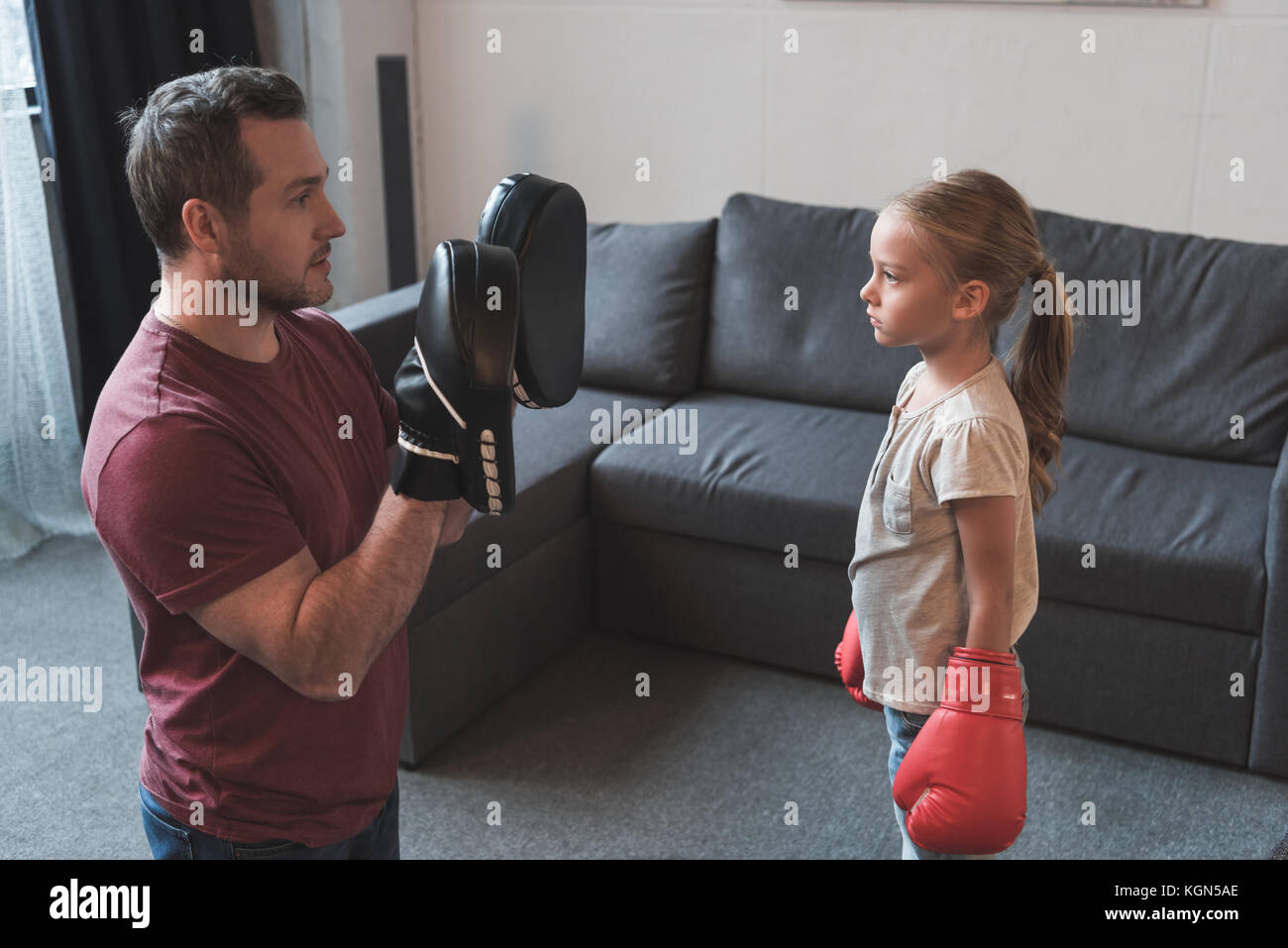 Father teaching daughter boxing Stock Photo - Alamy