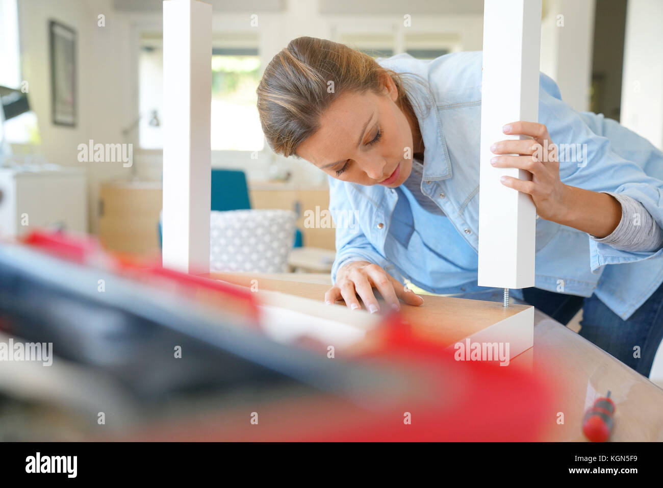 Woman doing DIY work, assembling furniture at home Stock Photo - Alamy