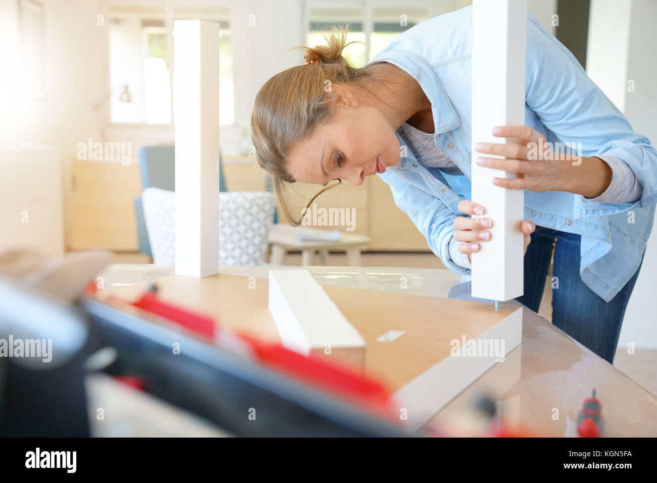 Woman doing DIY work, assembling furniture at home Stock Photo - Alamy