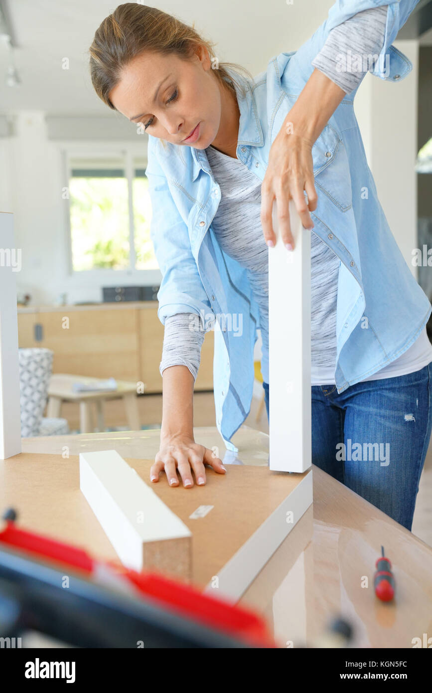 Woman doing DIY work, assembling furniture at home Stock Photo - Alamy