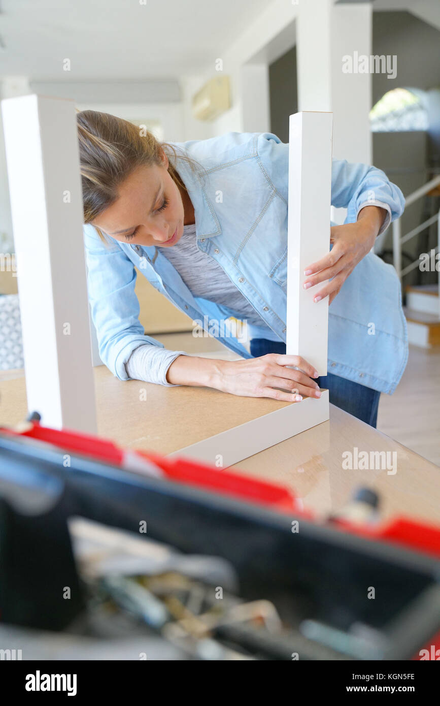 Woman doing DIY work, assembling furniture at home Stock Photo - Alamy