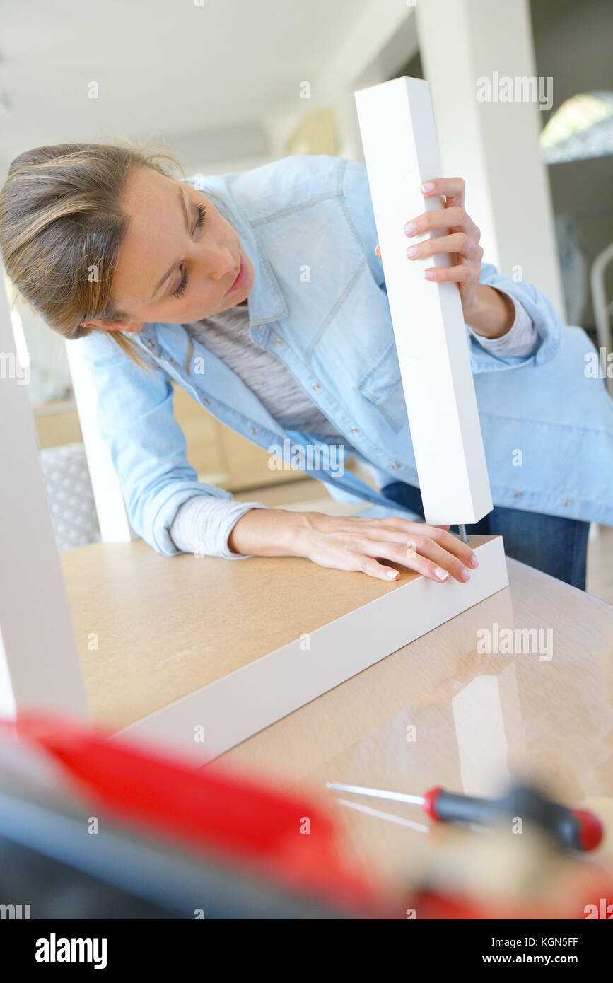 Woman doing DIY work, assembling furniture at home Stock Photo - Alamy