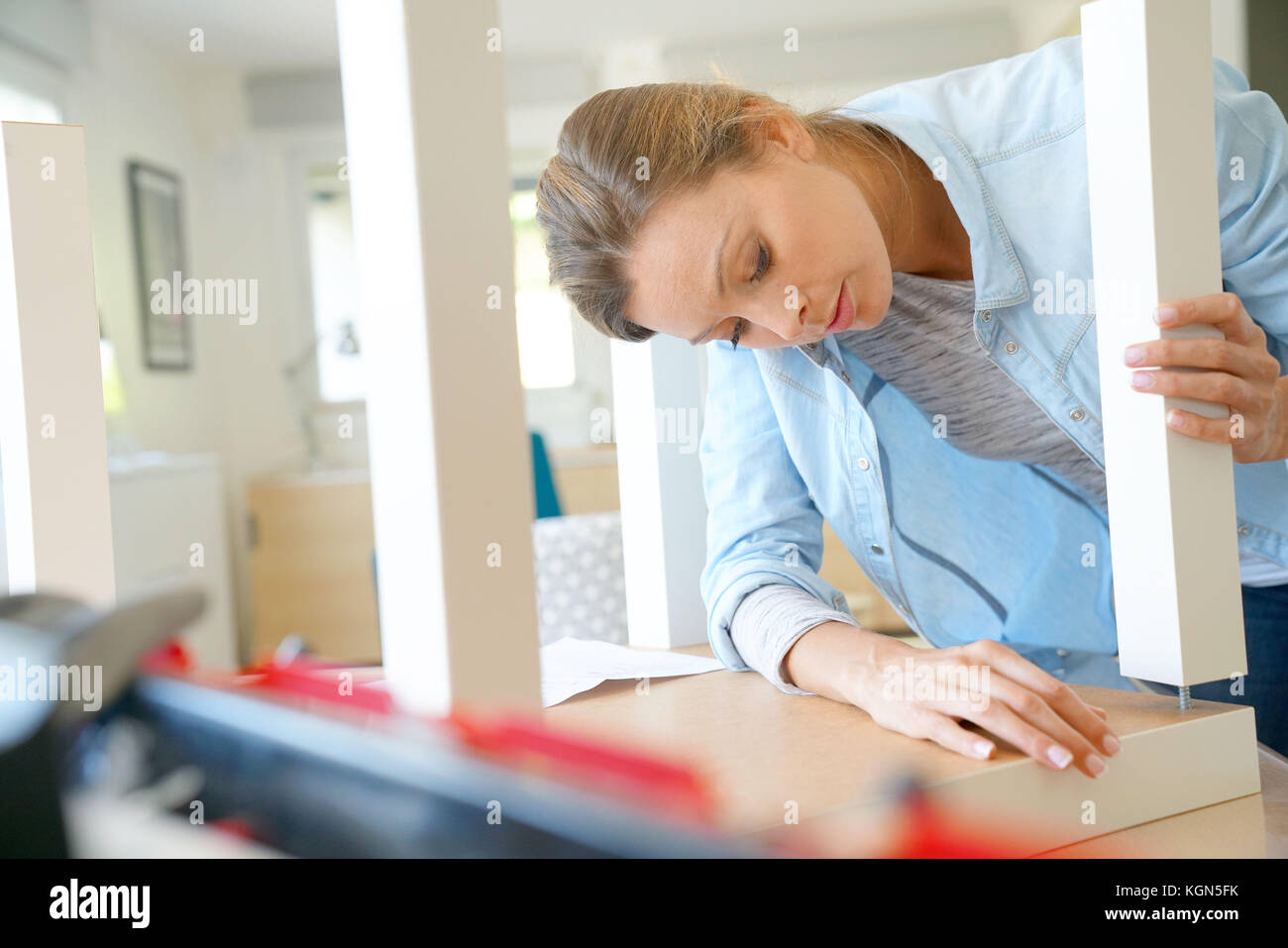 Woman doing DIY work, assembling furniture at home Stock Photo - Alamy