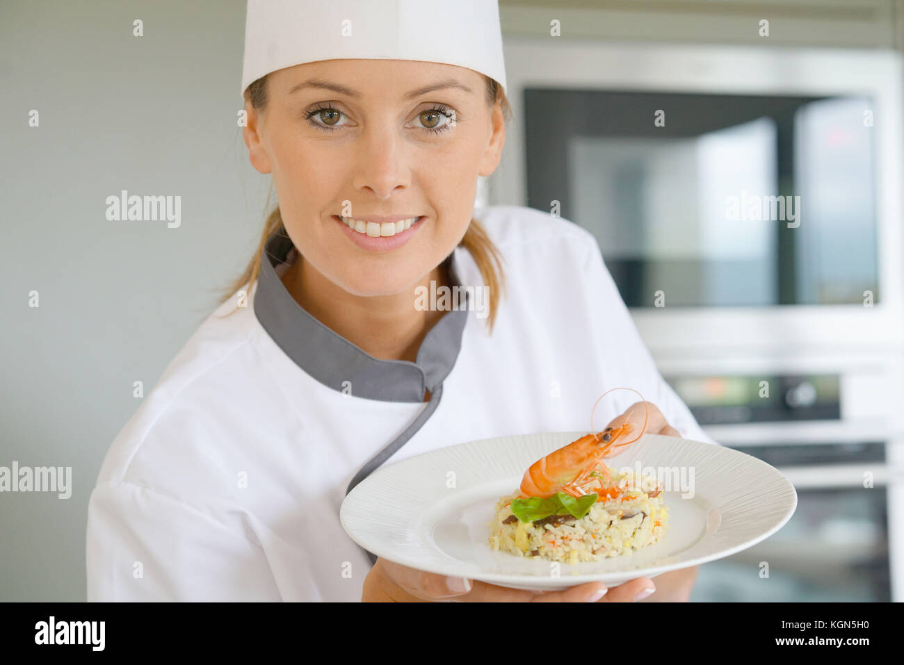Cook chef presenting dish to camera Stock Photo - Alamy