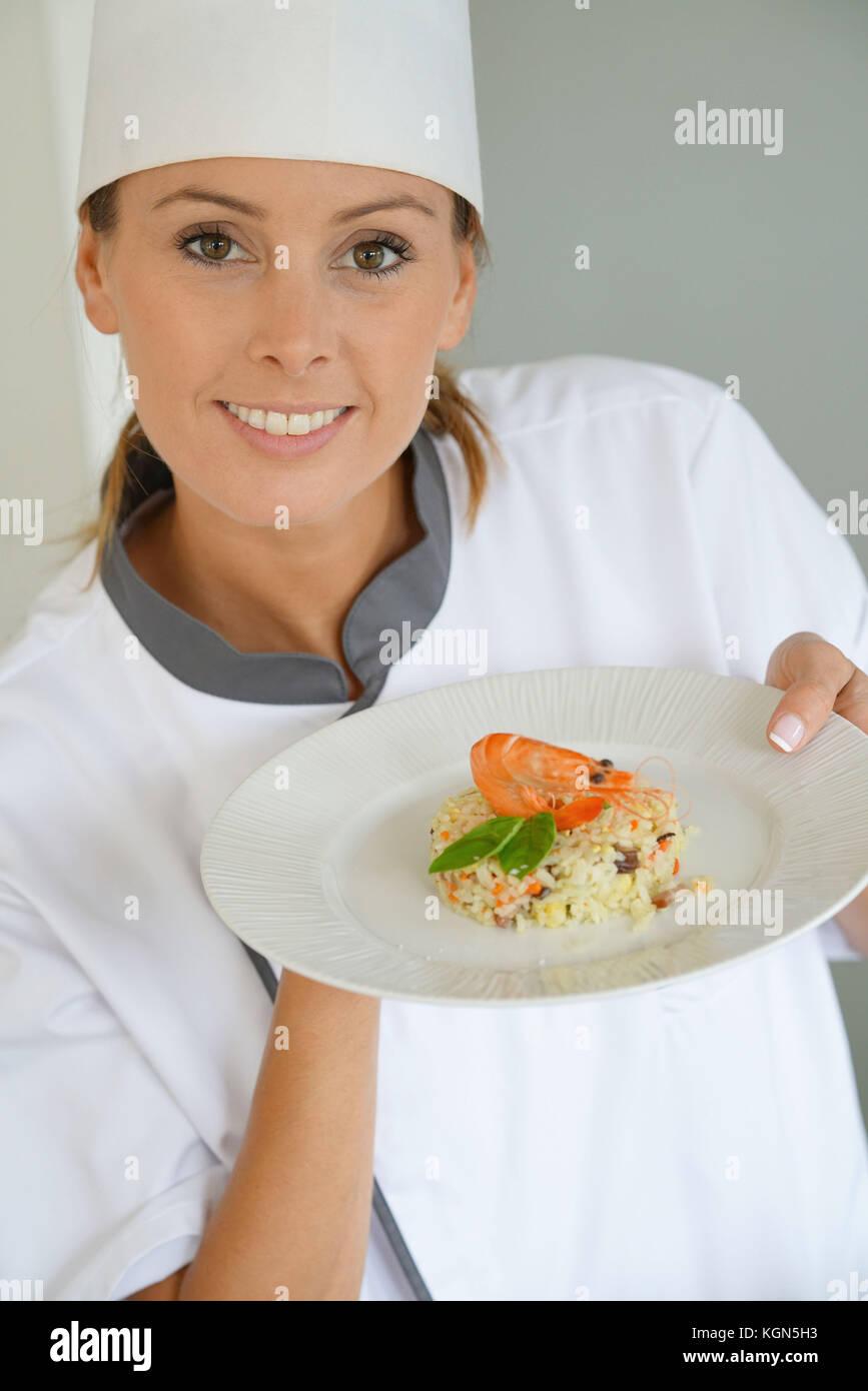 Cook chef presenting dish to camera Stock Photo - Alamy