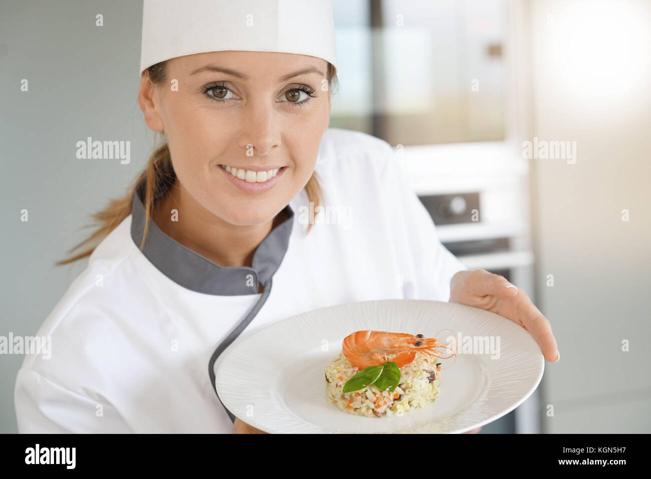 Cook chef presenting dish to camera Stock Photo - Alamy