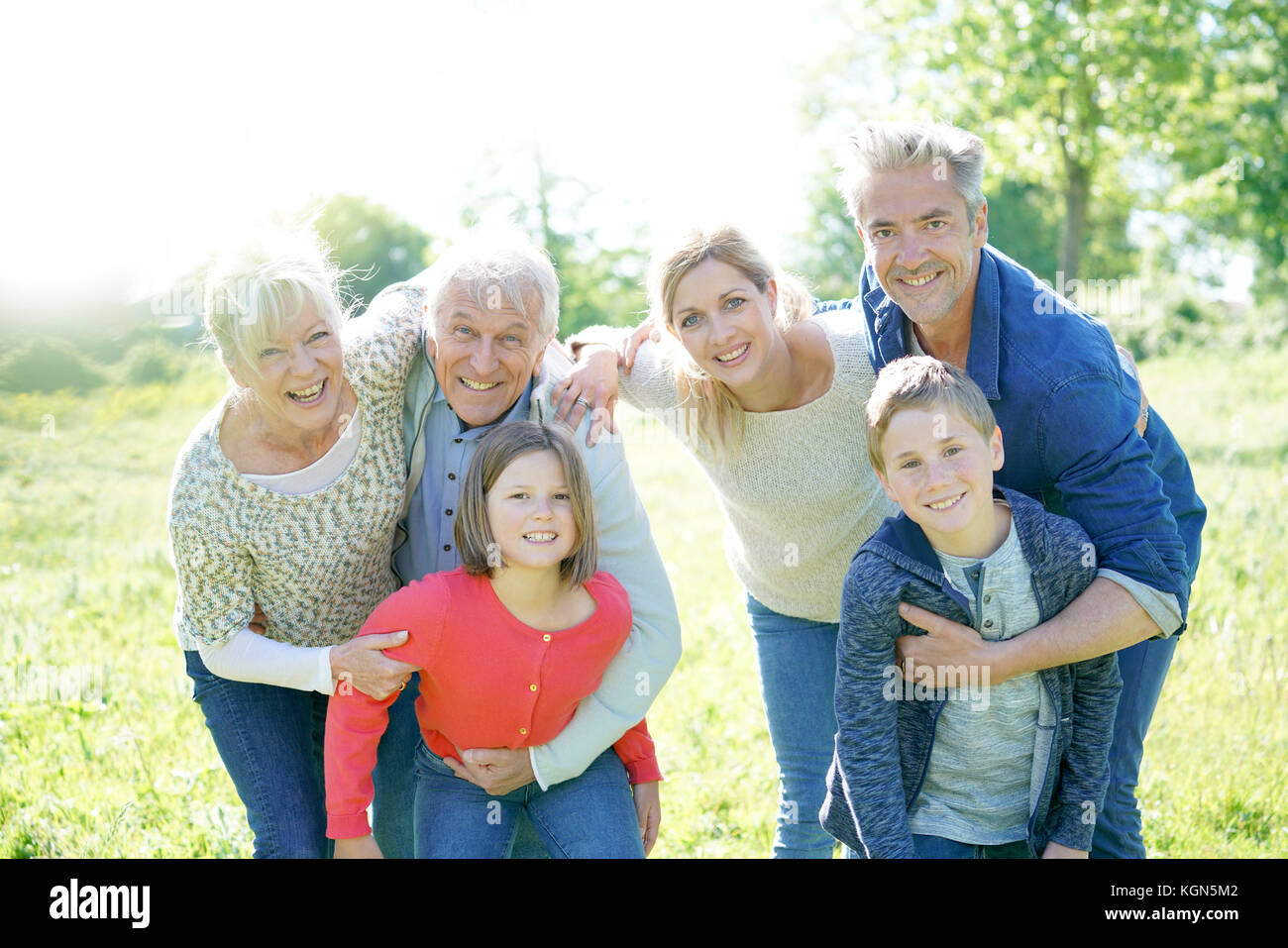 Intergenerational family walking together in park Stock Photo - Alamy