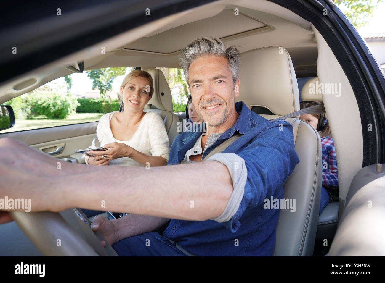 Family riding car, leaving for vacation Stock Photo - Alamy