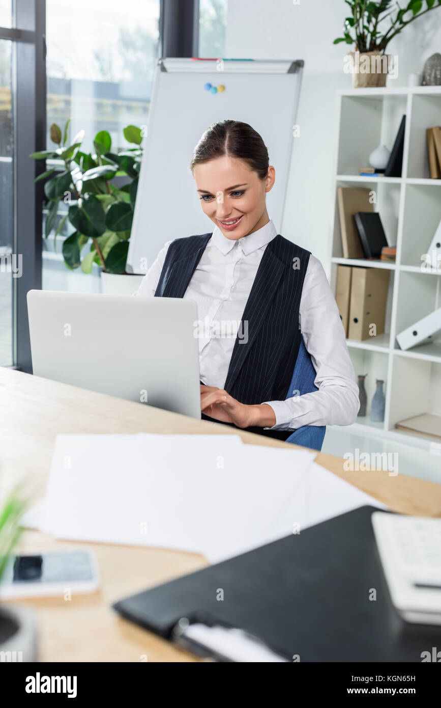 businesswoman in office using laptop Stock Photo - Alamy