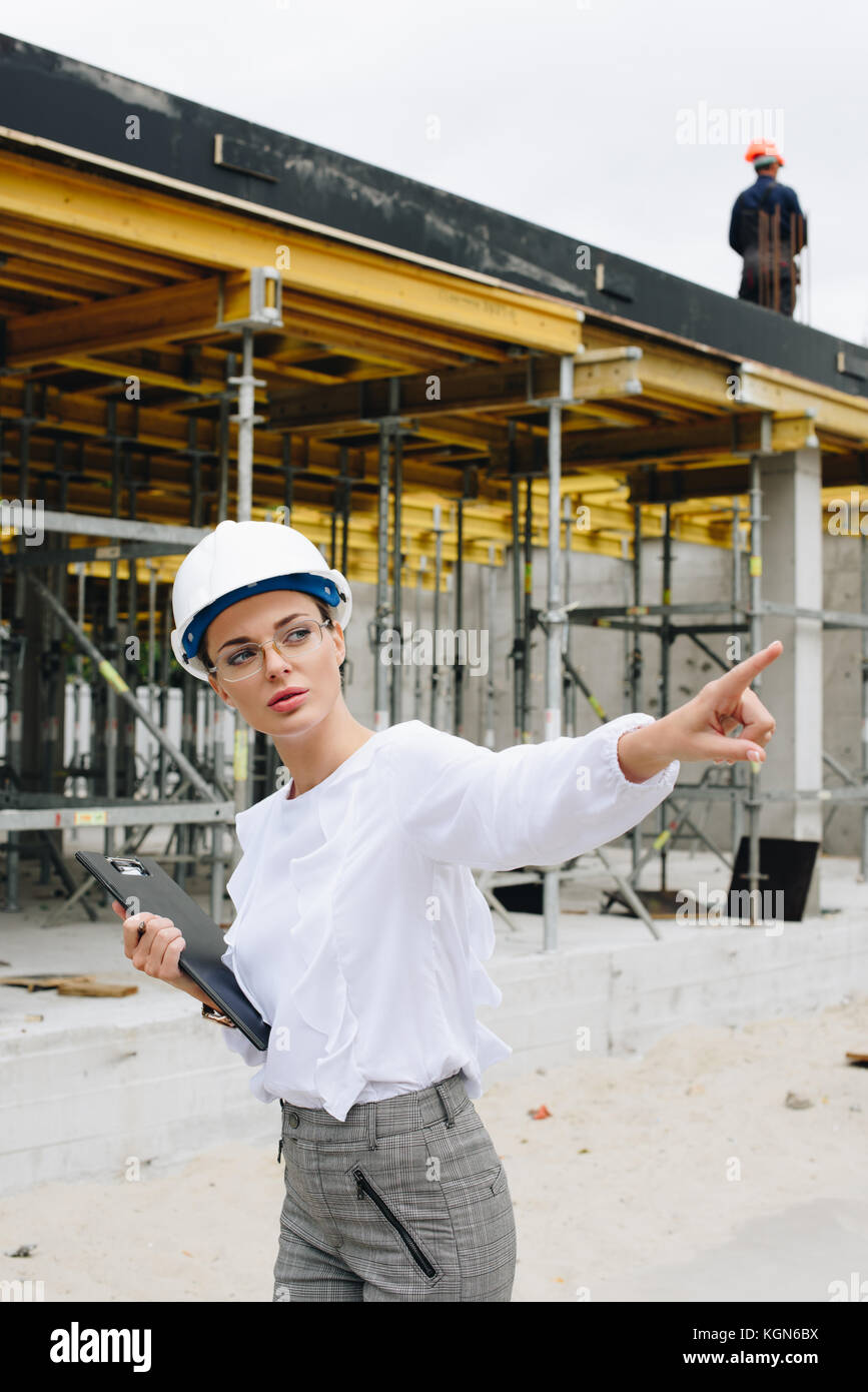 engineer pointing at construction site Stock Photo - Alamy
