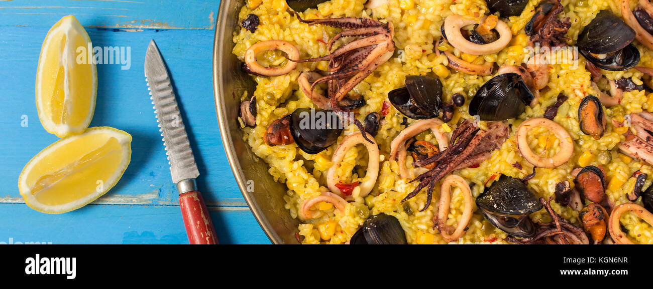 Spanish Seafood Paella in Traditional Pan on Rustic Wooden Table Stock ...