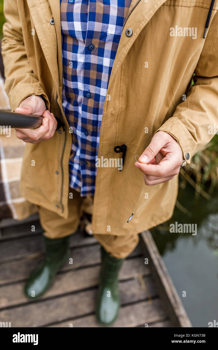 fisherman with rod and hook Stock Photo - Alamy