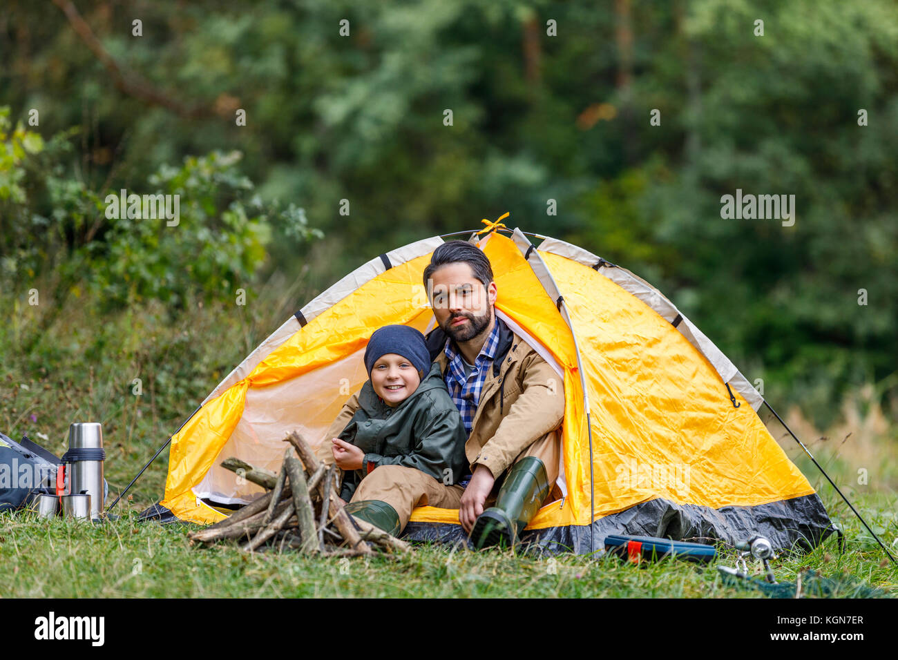 father and son sitting in tent Stock Photo - Alamy