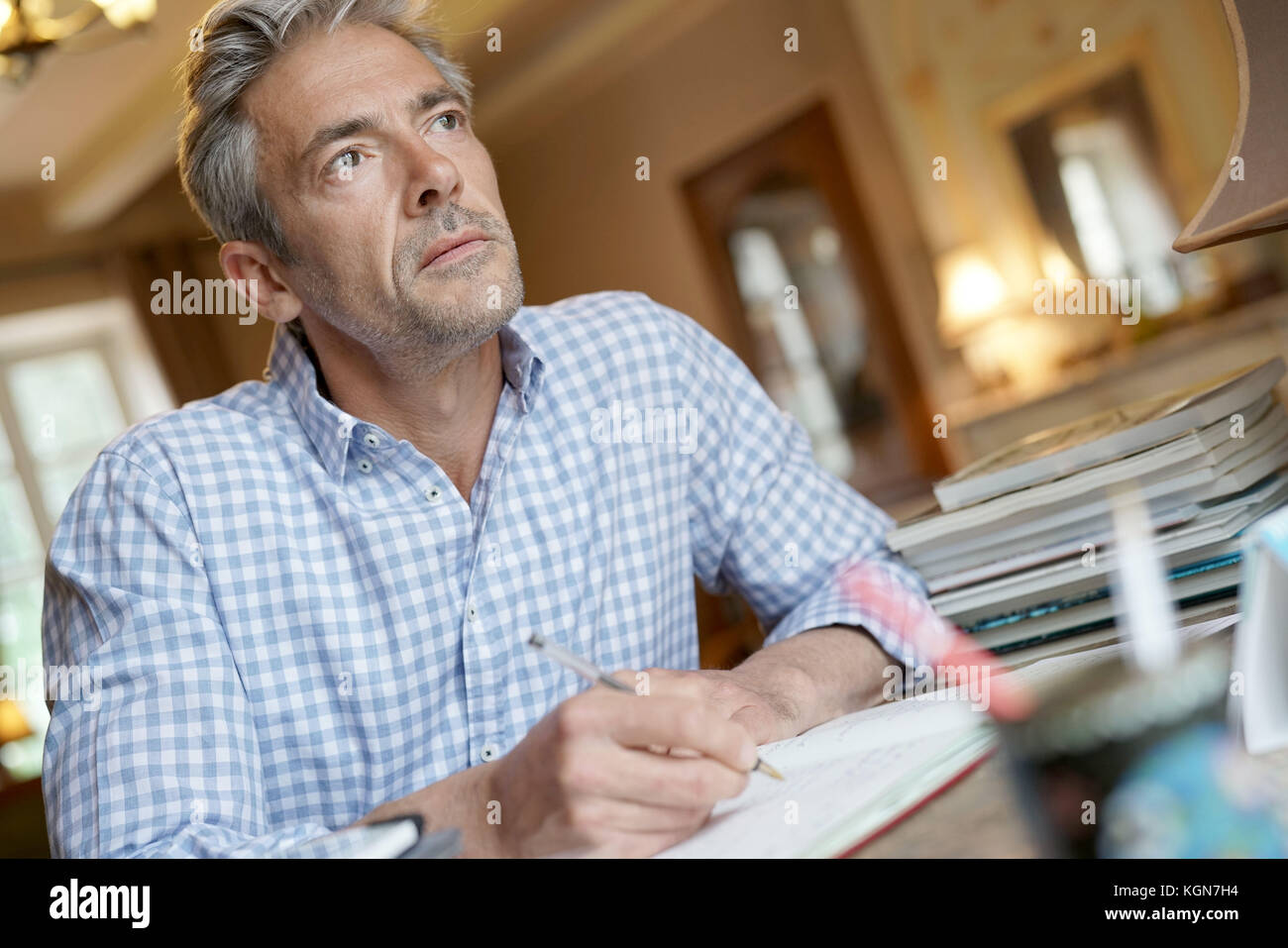 Mature adult man writing sitting hi-res stock photography and images ...